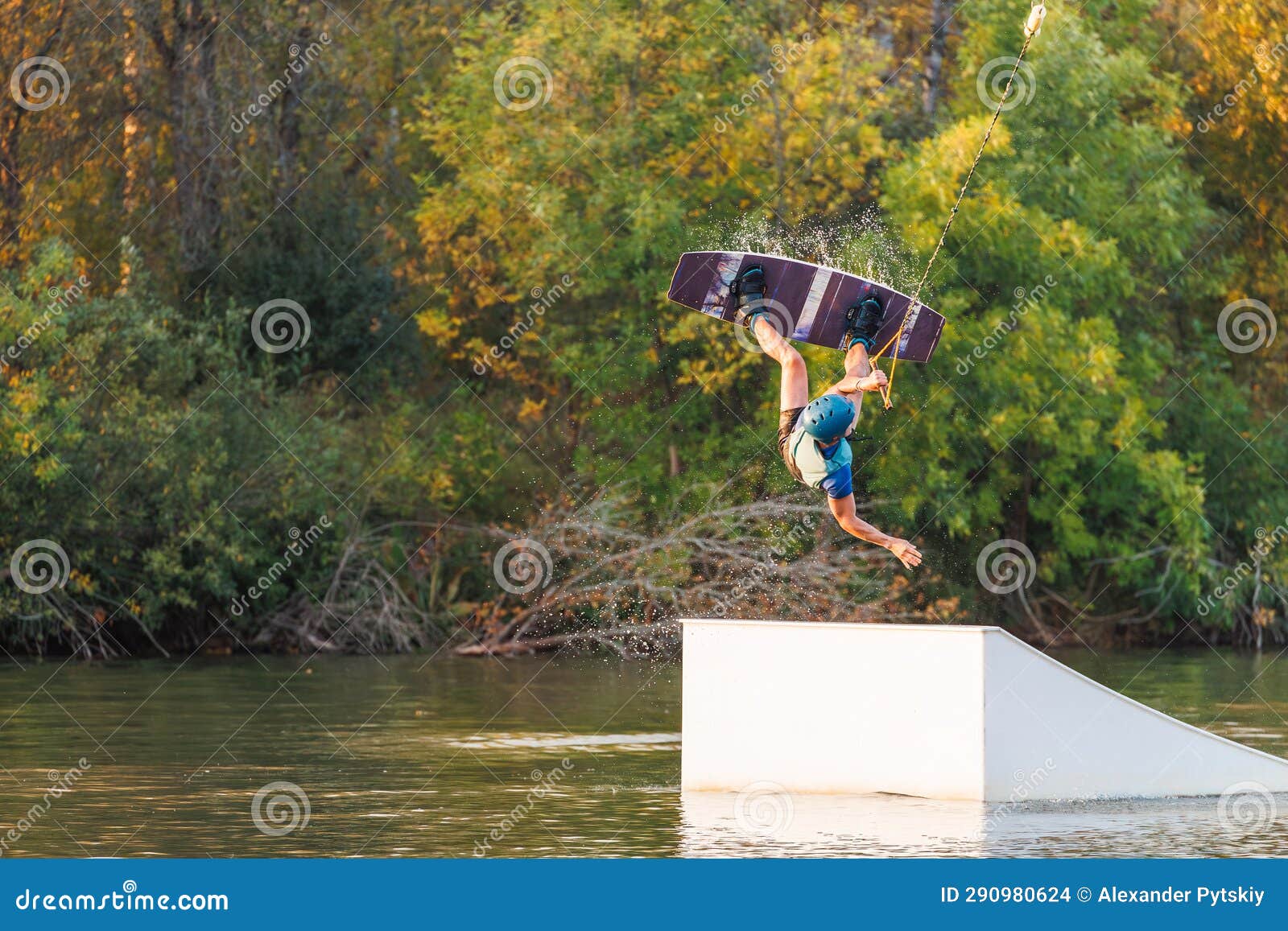 An Athlete Jumps from a Springboard. Wakeboard Park at Sunset Stock ...