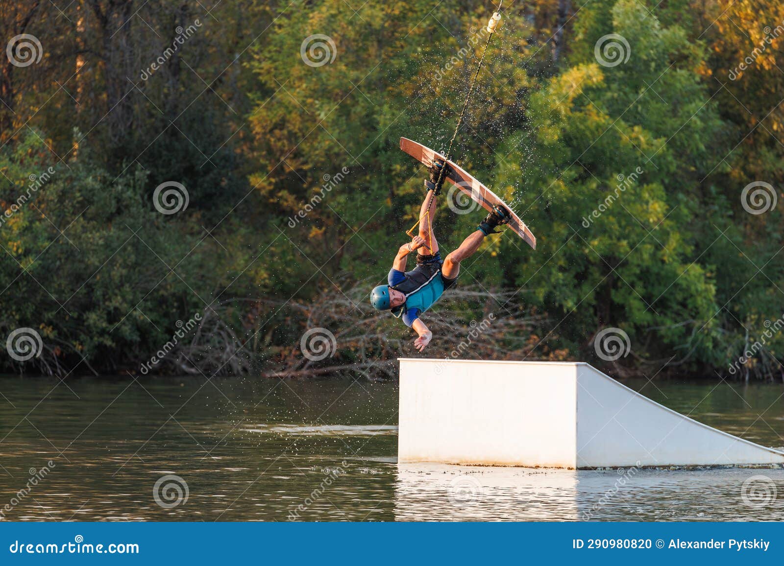 An Athlete Jumps from a Springboard. Wakeboard Park at Sunset Stock ...