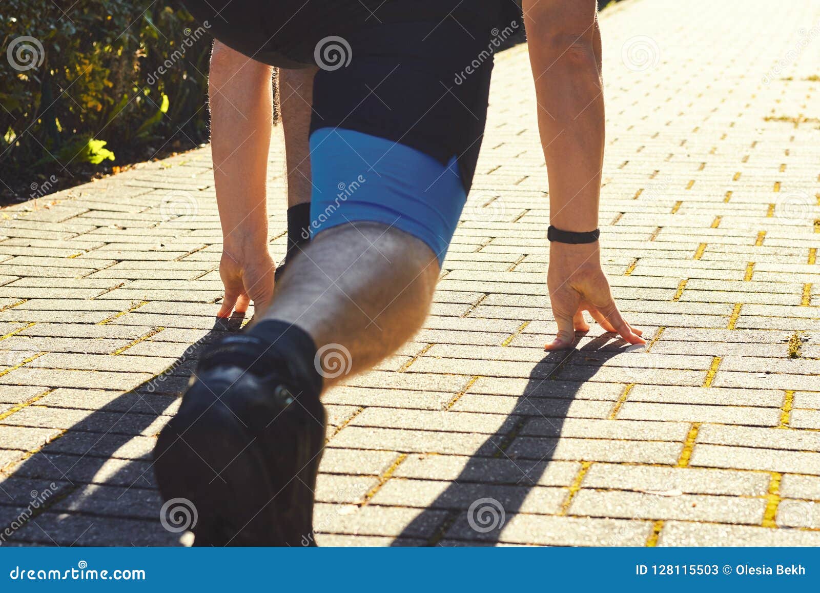 Athlete Man in Running Crouch Start Pose in Sunlight during Sunset ...