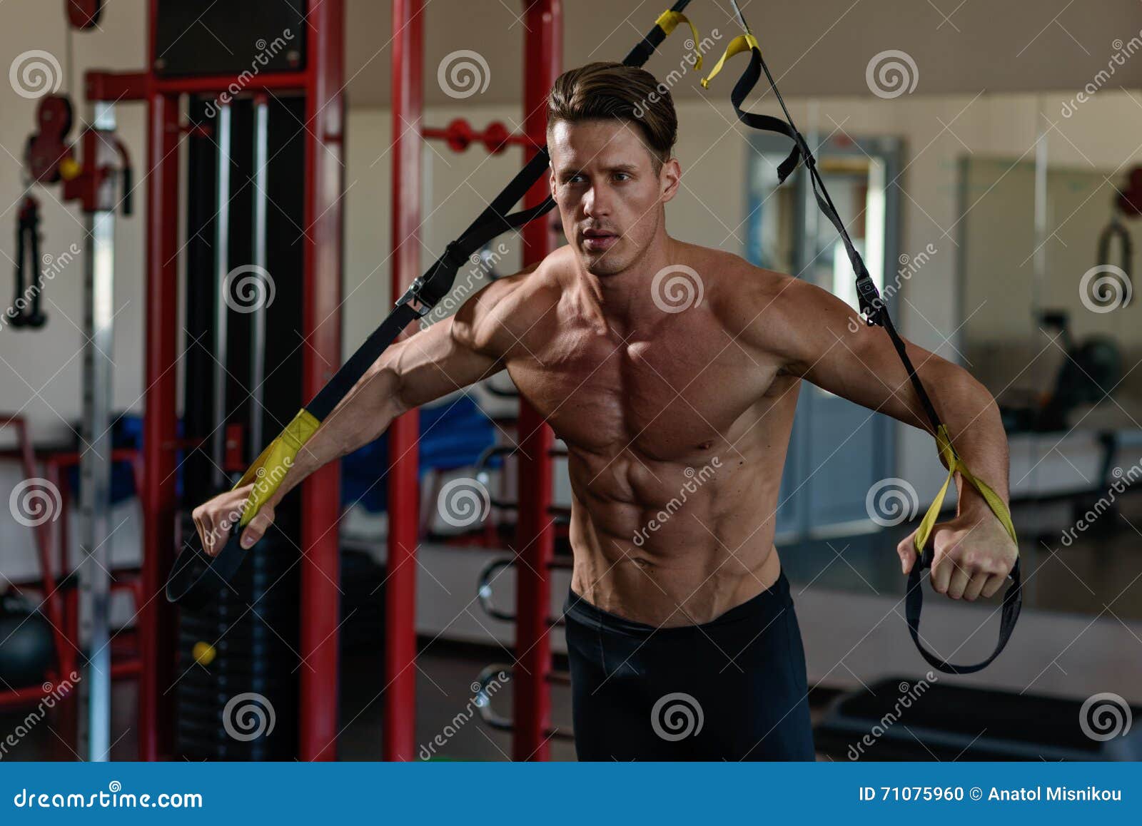 Athlete Muscular Bodybuilder Training on Simulator in the Gym. Stock ...