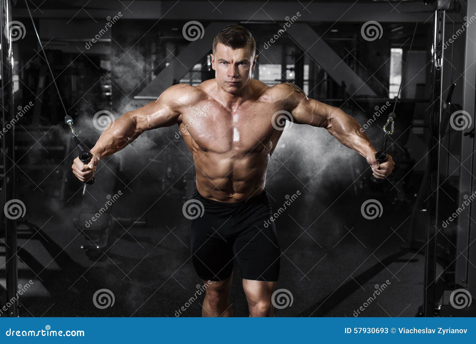 Athlete Muscular Bodybuilder Training on Simulator in the Gym Stock ...