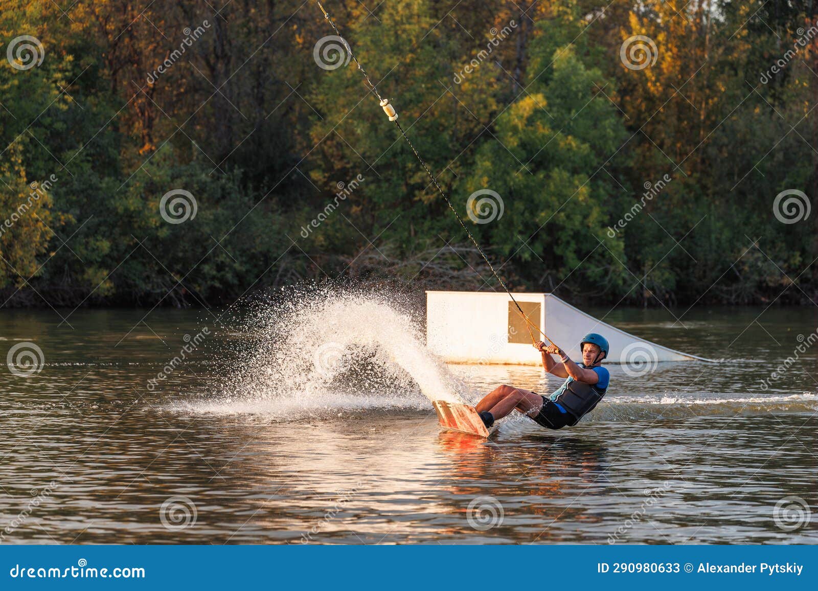 An Athlete Performs a Trick on the Water. Park at Sunset Stock Image ...