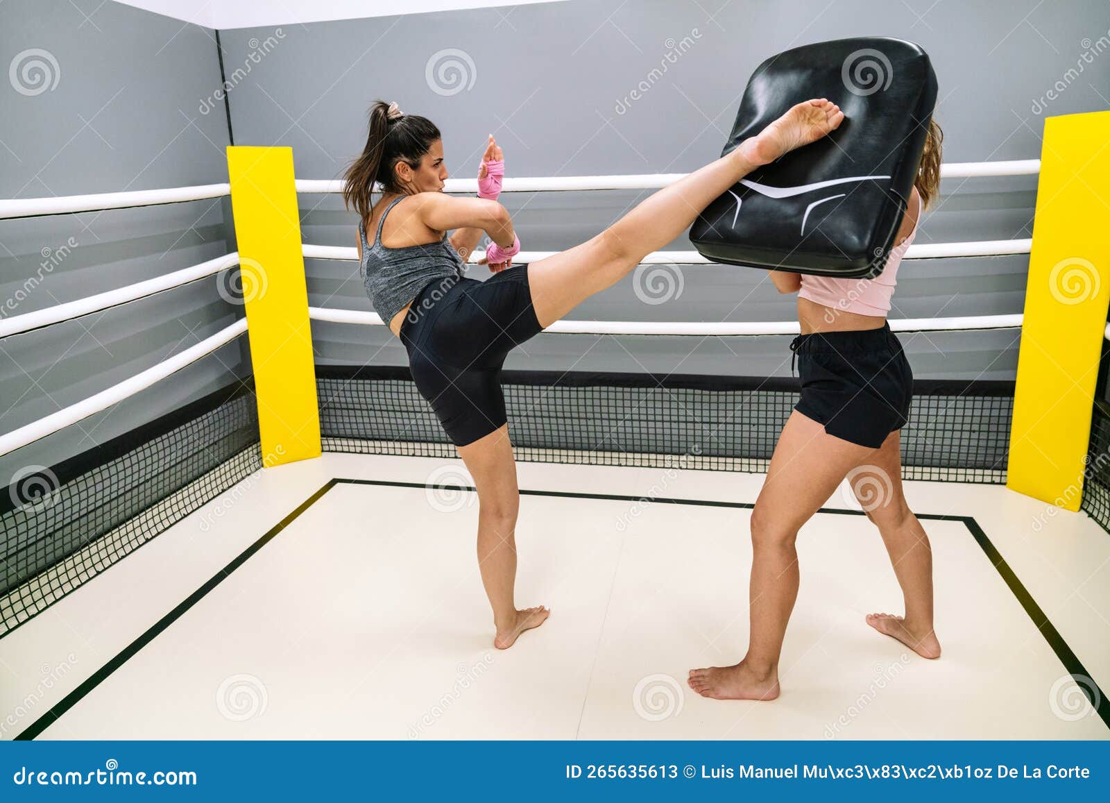 Athlete Practicing High Kick with Her Partner in the Ring at a ...
