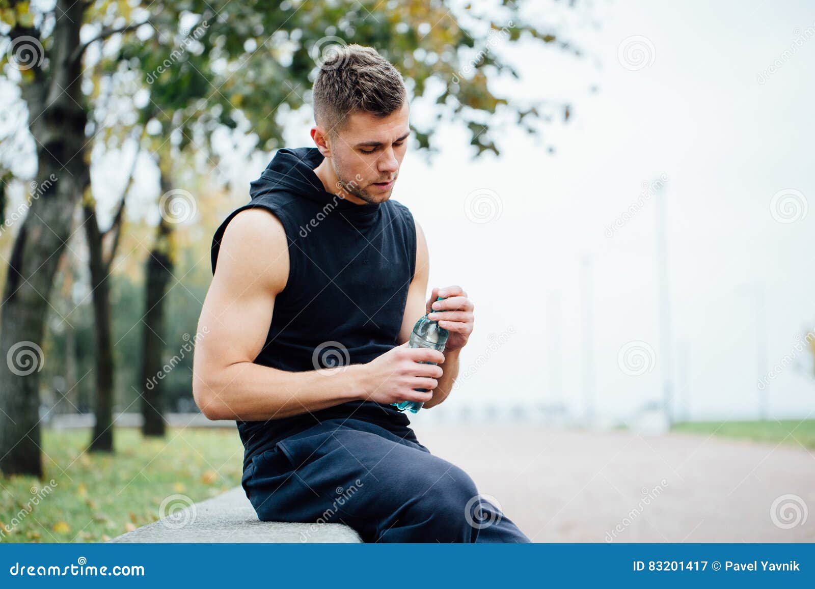 Athlete Resting on Bench in Park after Running with Bottle of Water ...