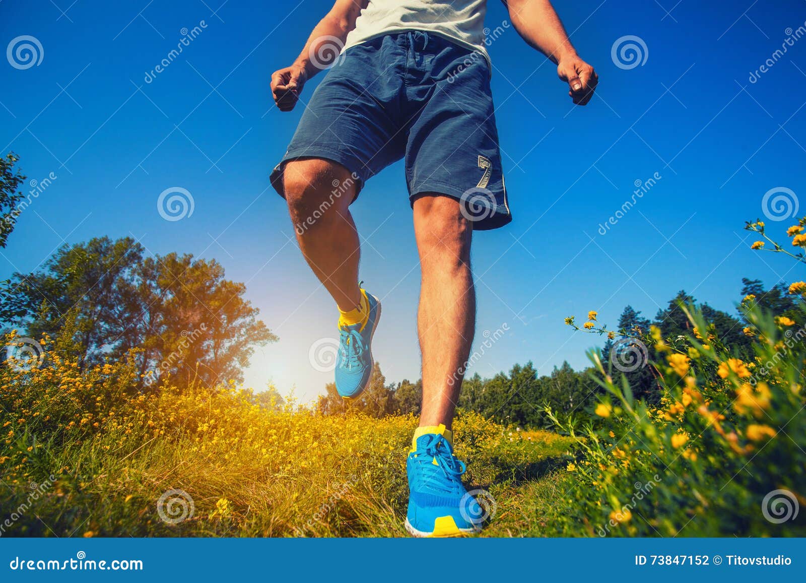 Athlete Running through the Meadow. Stock Photo - Image of sneakers ...