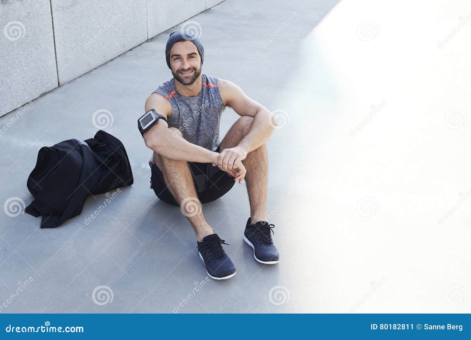 Athlete sitting on ground stock image. Image of confidence - 80182811