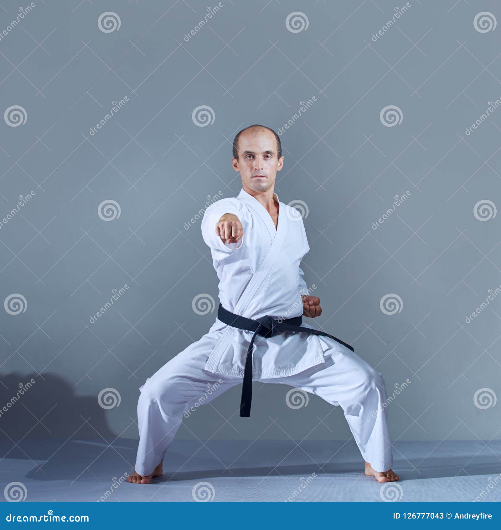 The Athlete Strikes with a Hand in the Karate Rack Against a Dark ...