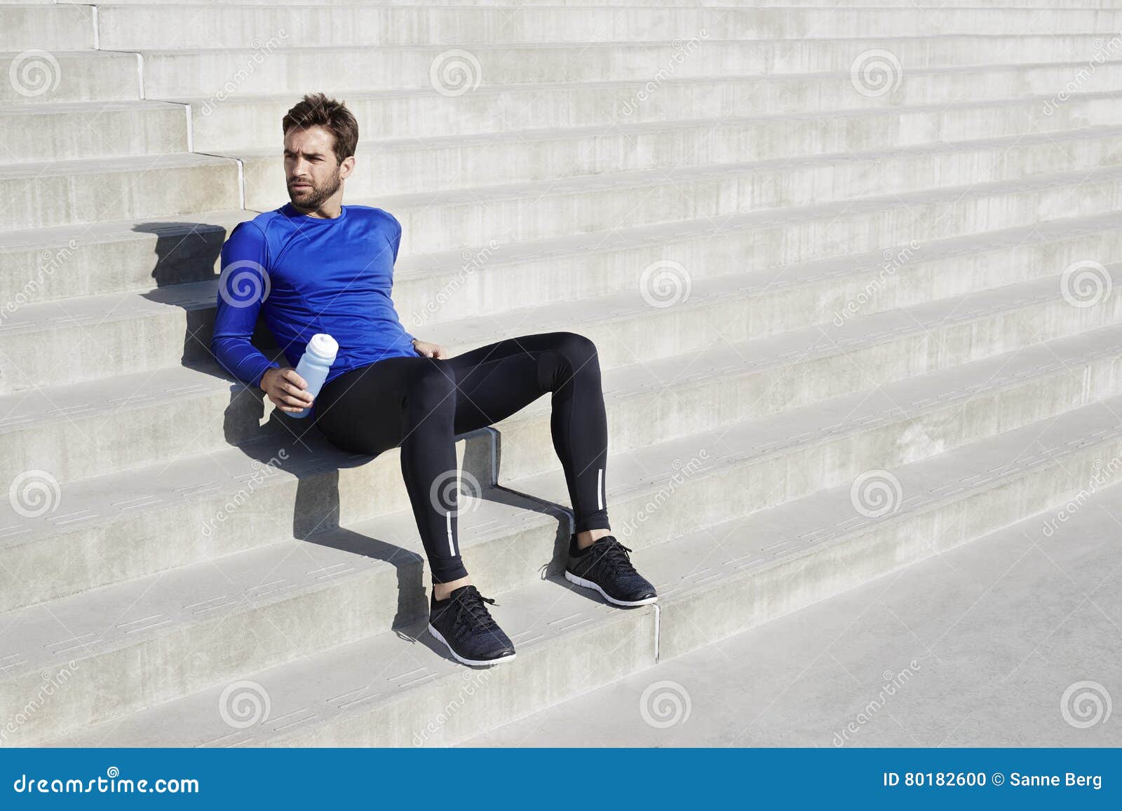 Athlete Taking a Break on Steps Stock Photo - Image of blue ...