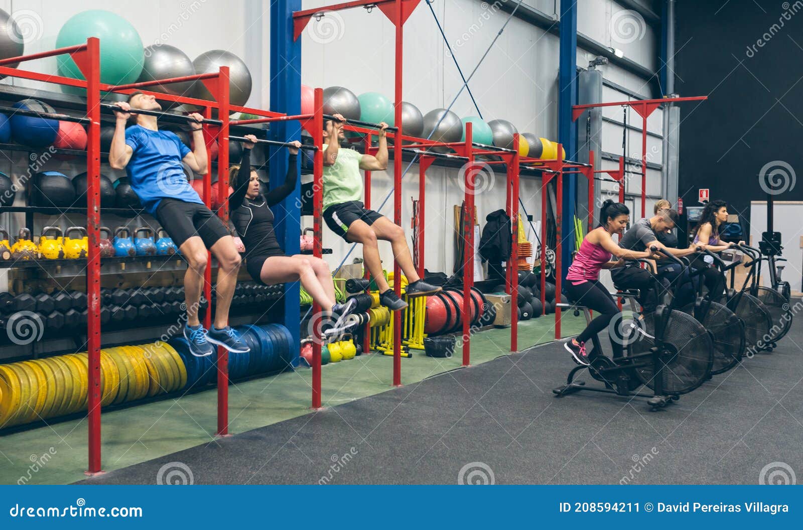 Athletes Doing Pull Ups and Air Bike in the Gym Stock Image - Image of ...