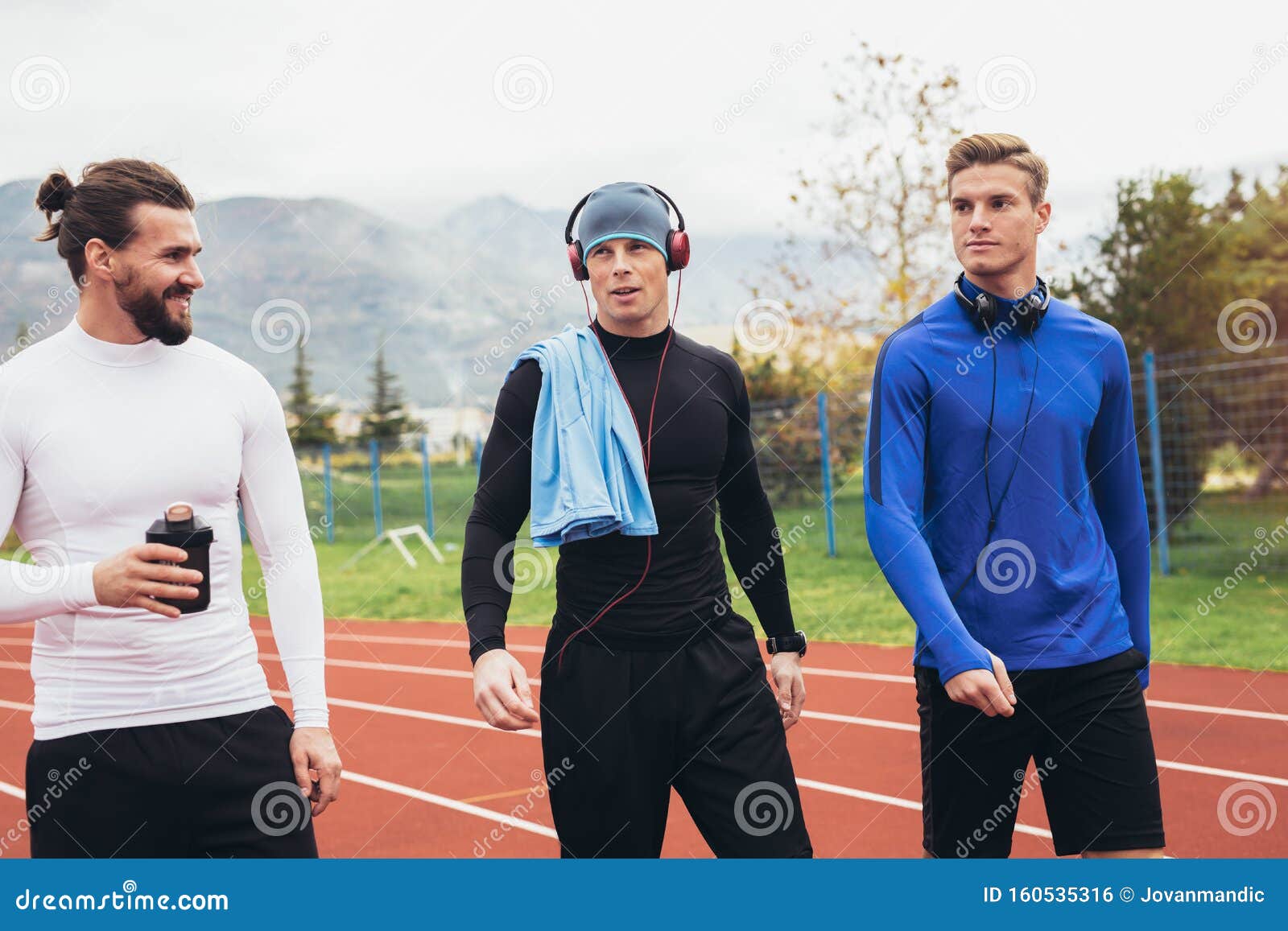 Athletes Practicing a Run on Athletics Stadium Track, Having Break ...
