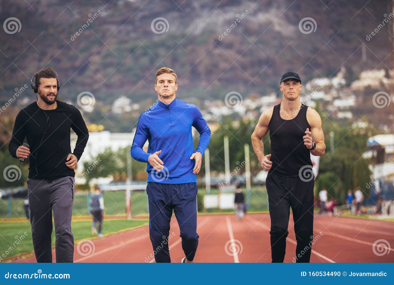 Athletes Practicing a Run on Athletics Stadium Track Stock Photo ...