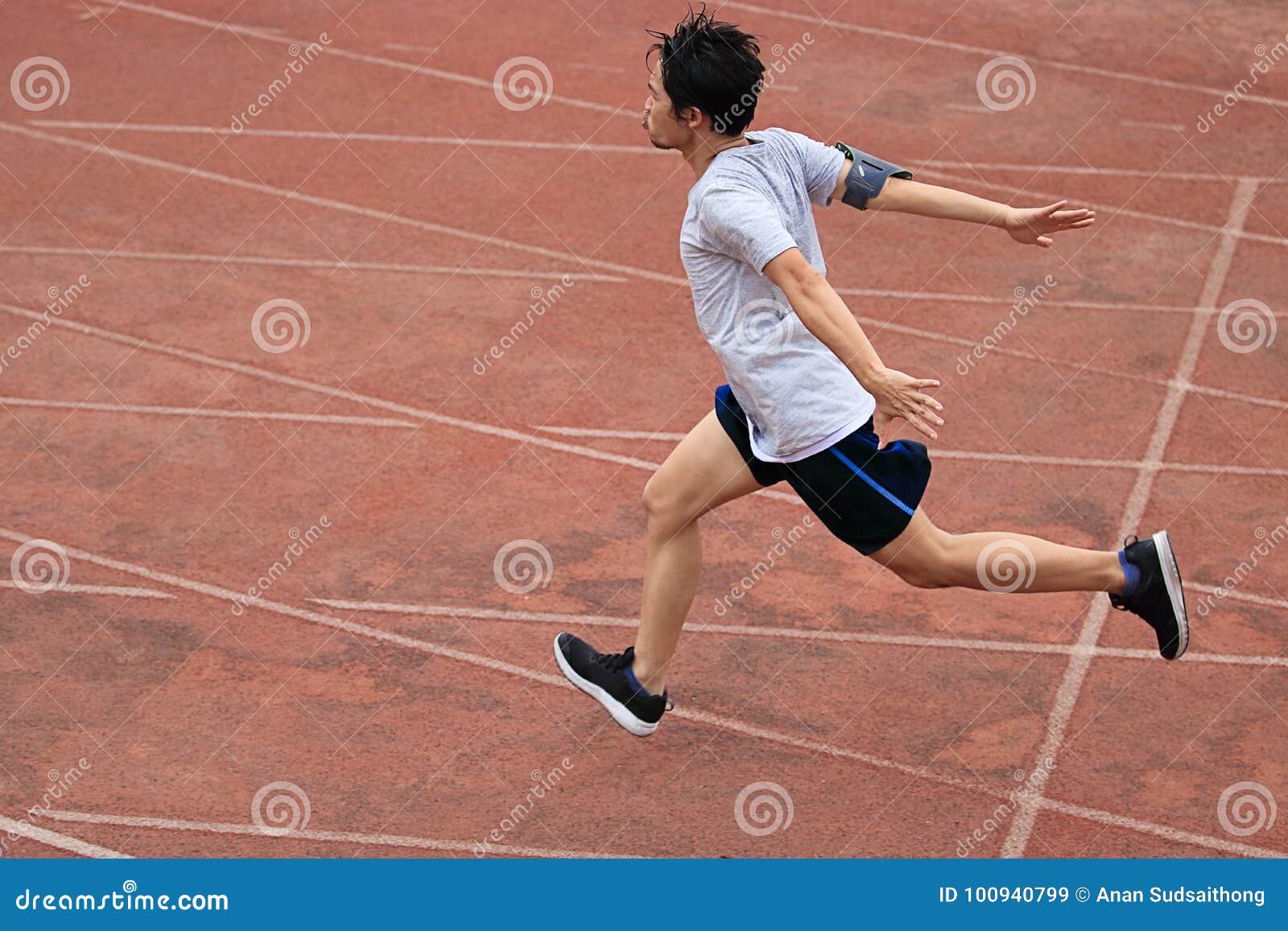 Athletic Asian Runner Sprinter Crossing The Finish Line. Royalty-Free ...