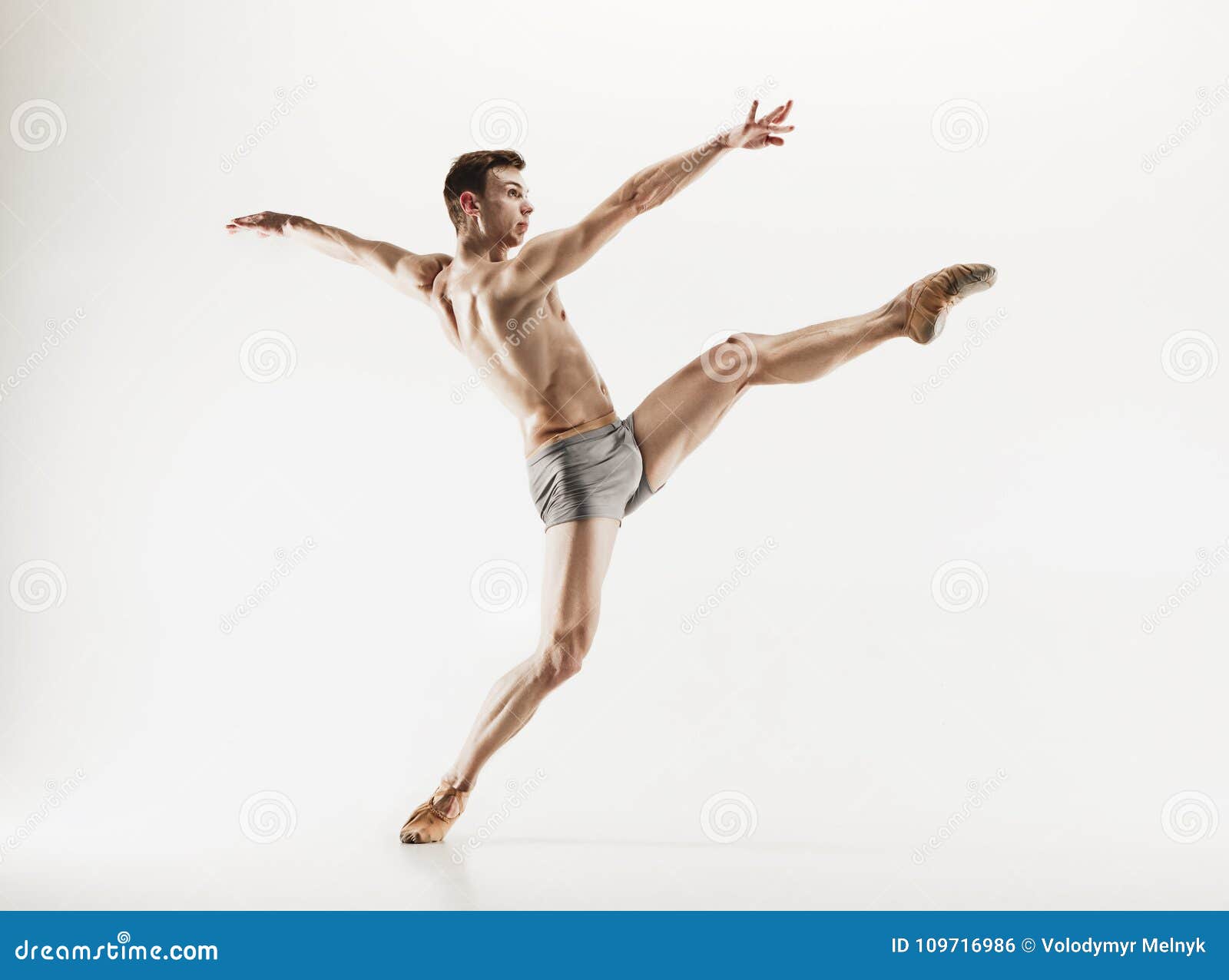 Athletic Ballet Dancer in a Perfect Shape Performing Over the Grey ...