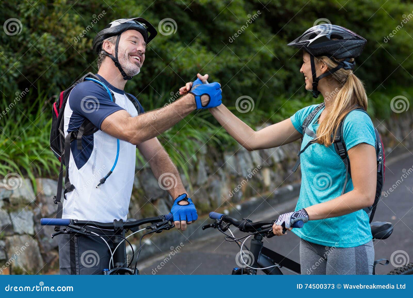Athletic Couple Holding Hands while Riding Bicycle Stock Image - Image ...