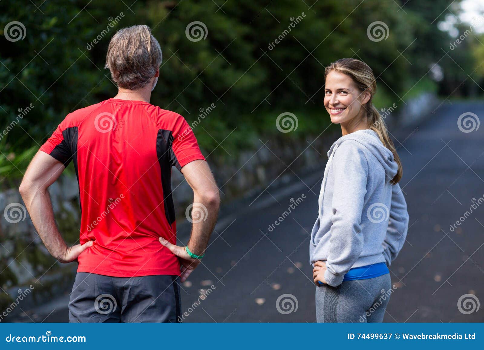 Athletic Couple Standing with Hands on Hip on the Road Stock Image ...