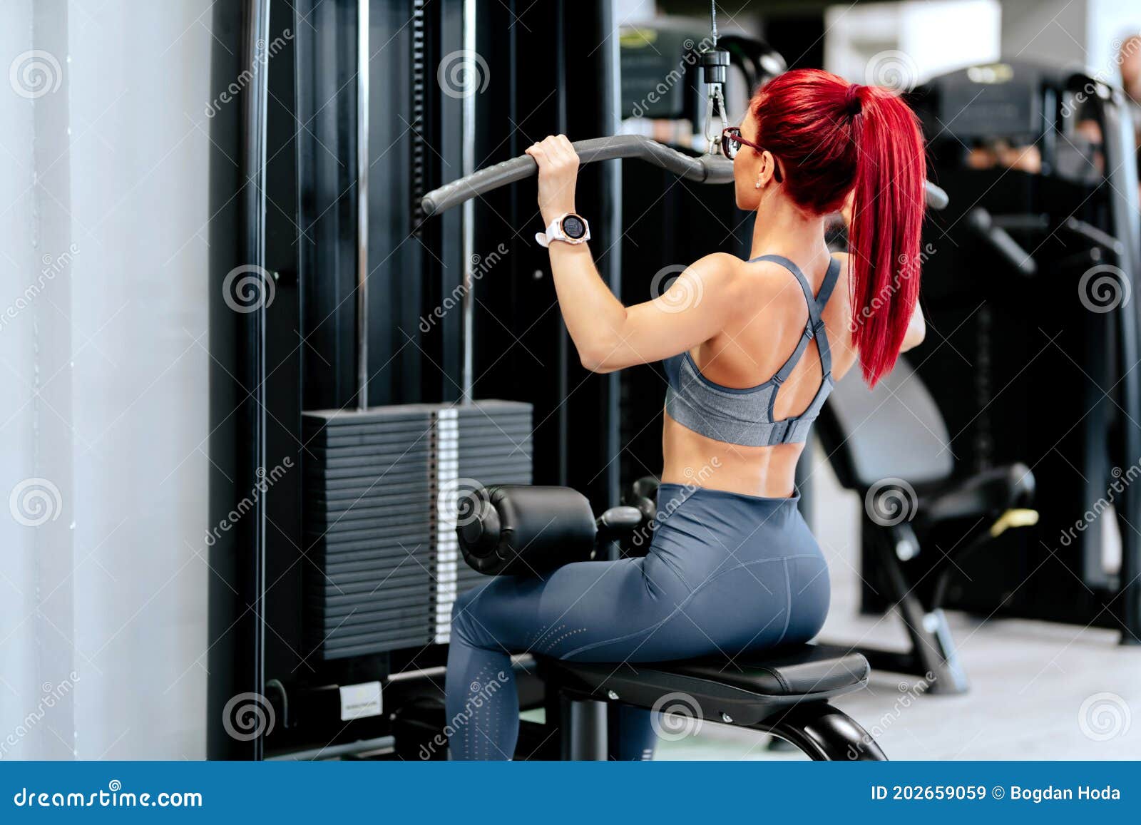 Behind View - Athletic Female Doing Back and Shoulders Exercises Stock ...