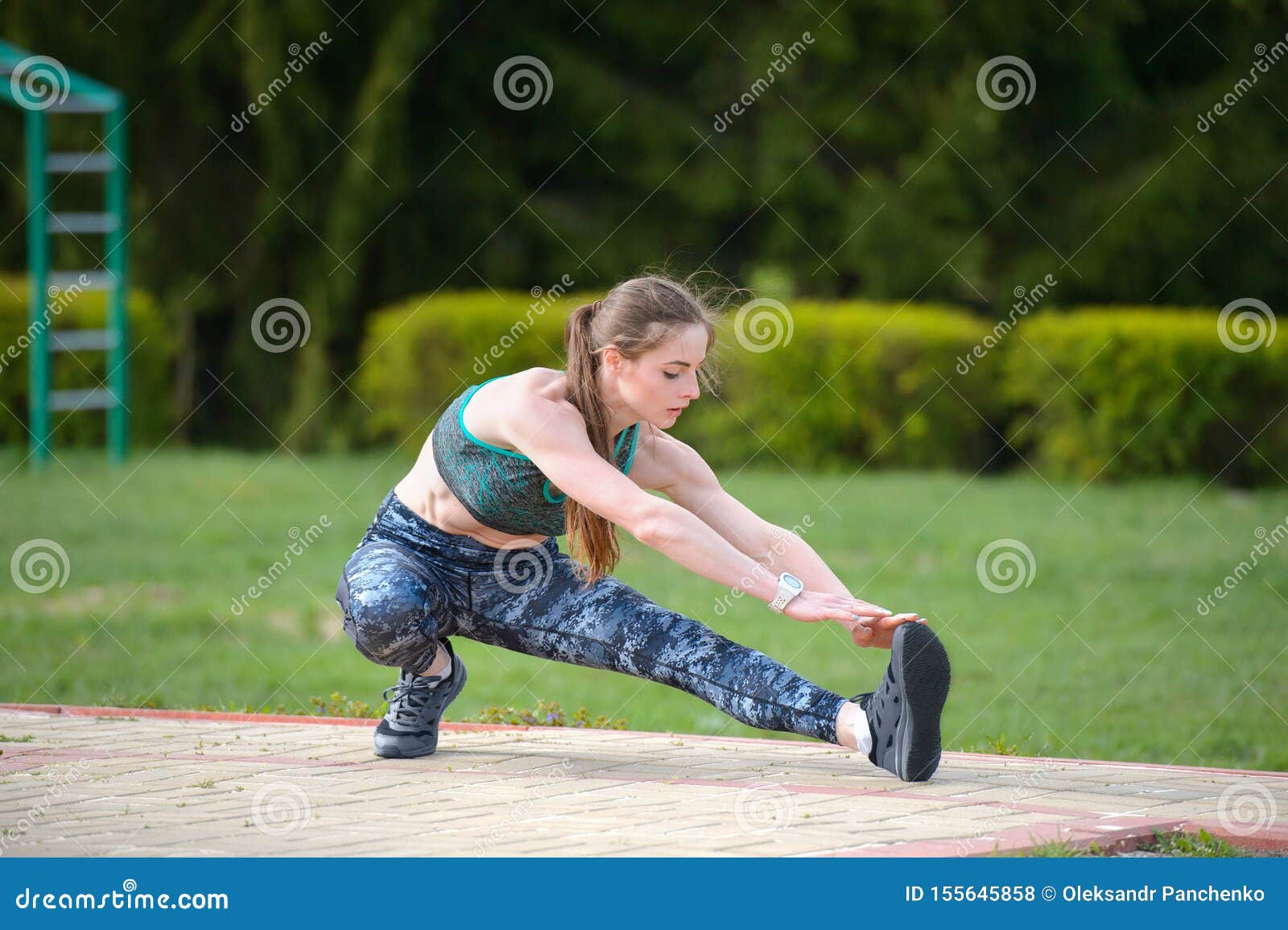 Athletic Girl Performs Hamstring and Stretching Exercises Stock Photo ...
