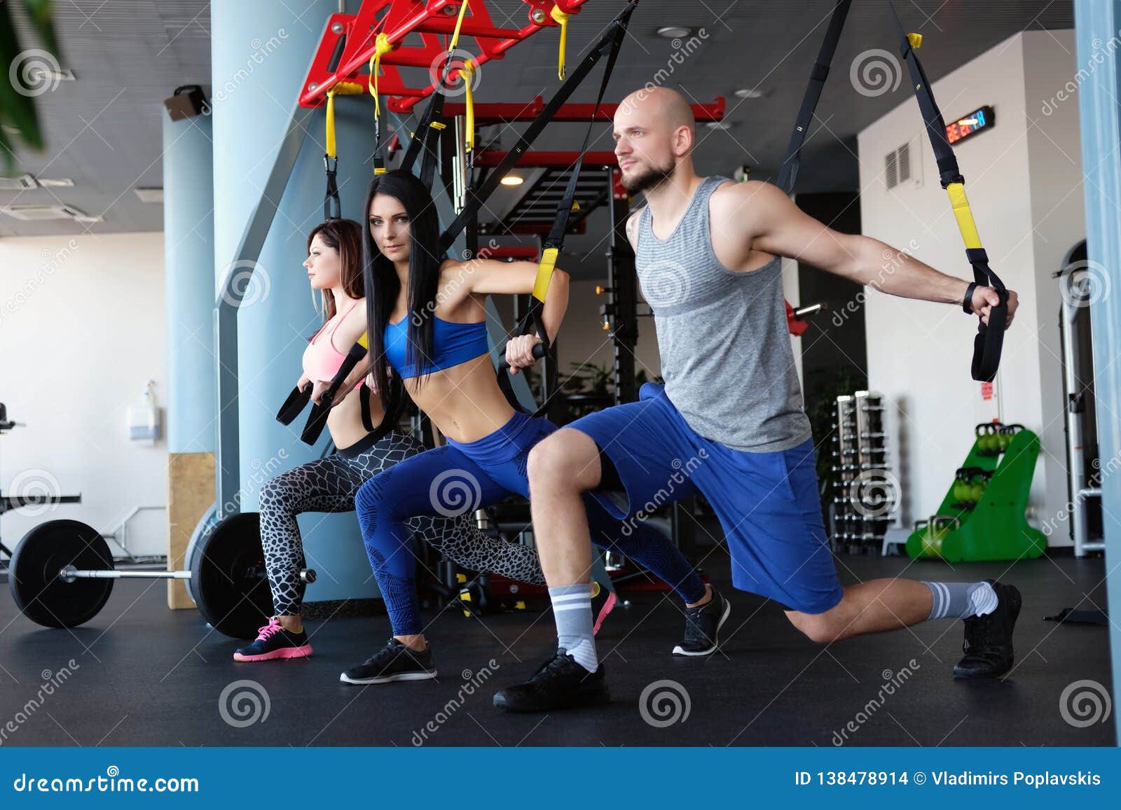 Athletic Group Doing Crossfit Training with Functional Loops in the Gym ...