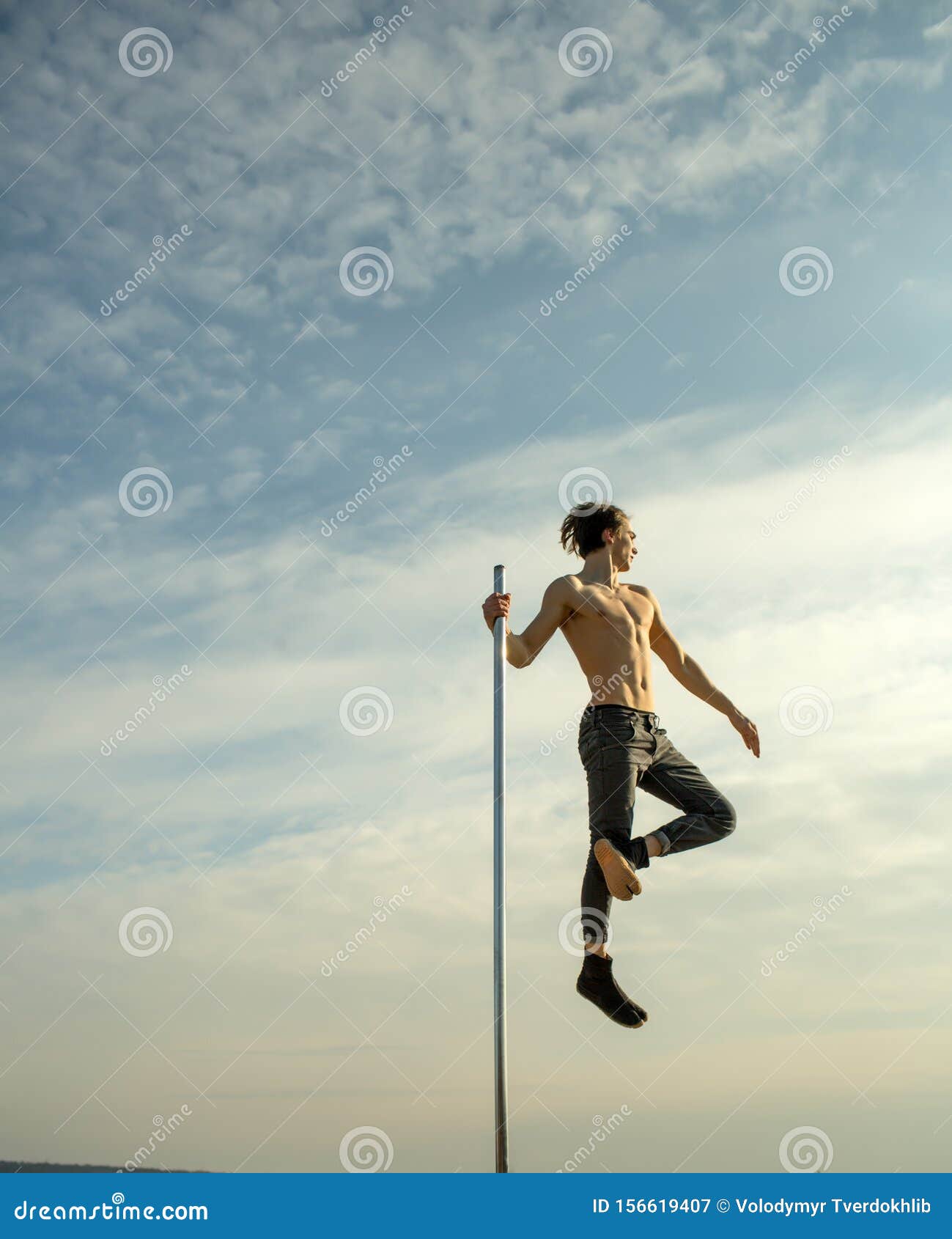 Athletic Guy Make Acrobatic Elements On Pylon Strong Man Dancer