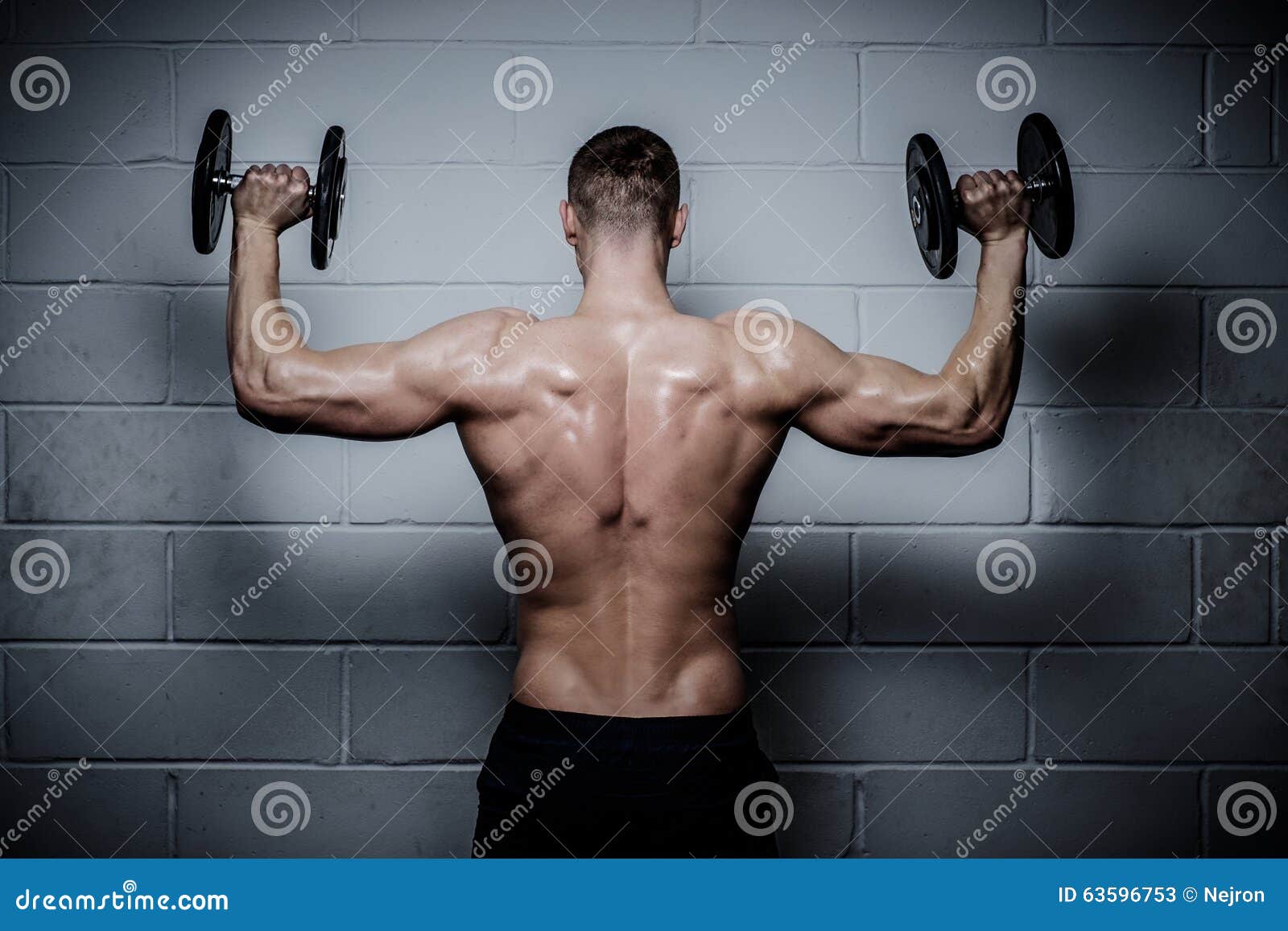 Athletic Man Doing Exercises with Dumbbells in the Gym S Stock Image ...