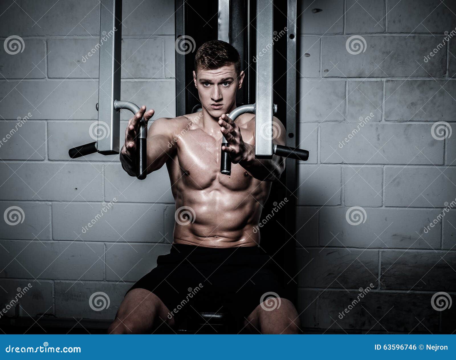 Athletic Man Doing Exercises on Training Apparatus Stock Photo - Image ...