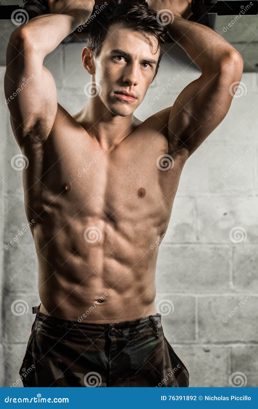 Athletic Man Flexing stock photo. Image of trousers, muscle - 76391892