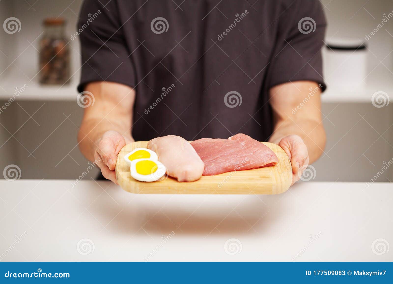 Athletic Man Holding a Board with Meat for Proper Nutrition of the ...