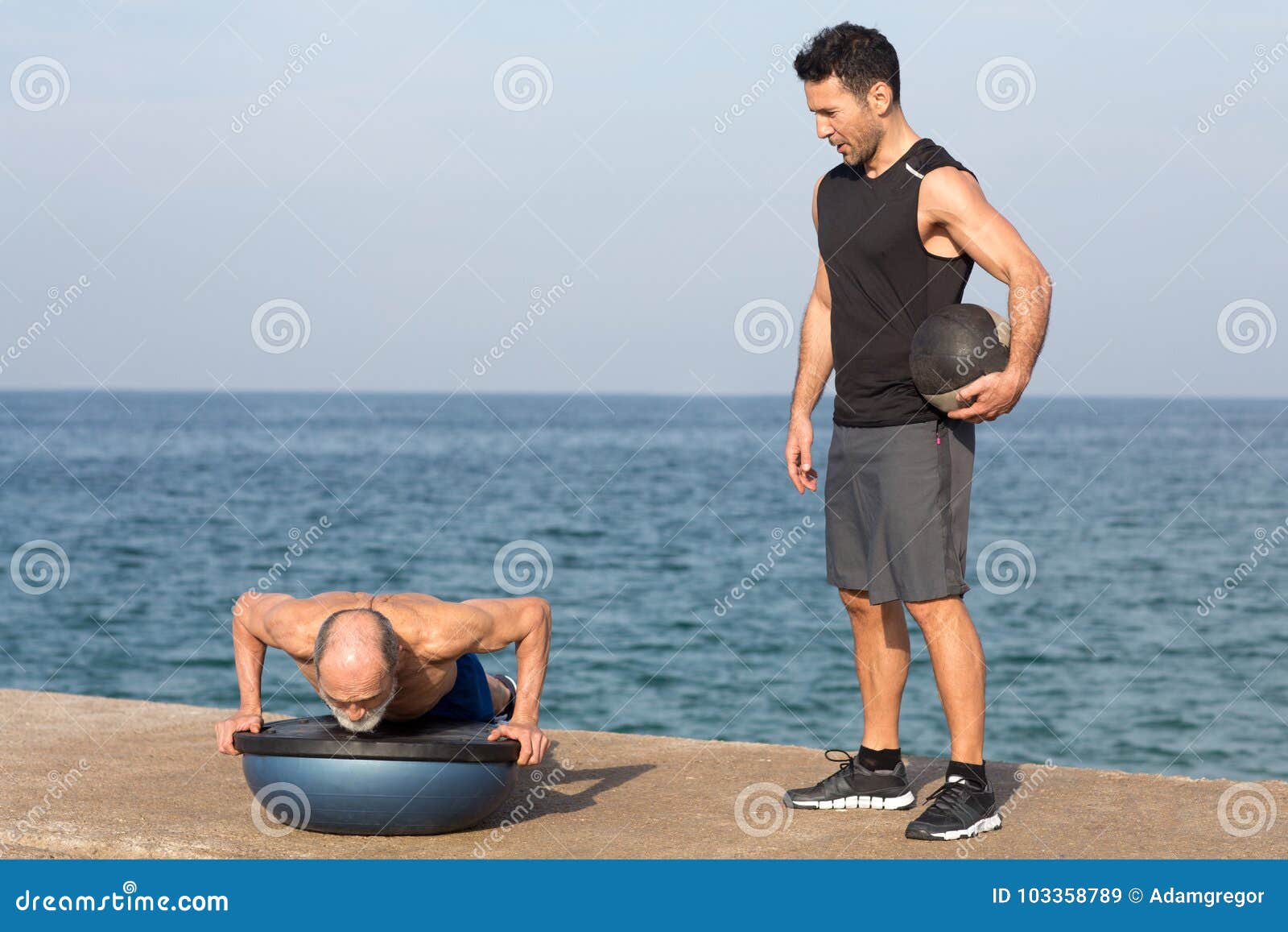 Athletic Man Making a Push-up Exercise with Coach on Balance Platform ...