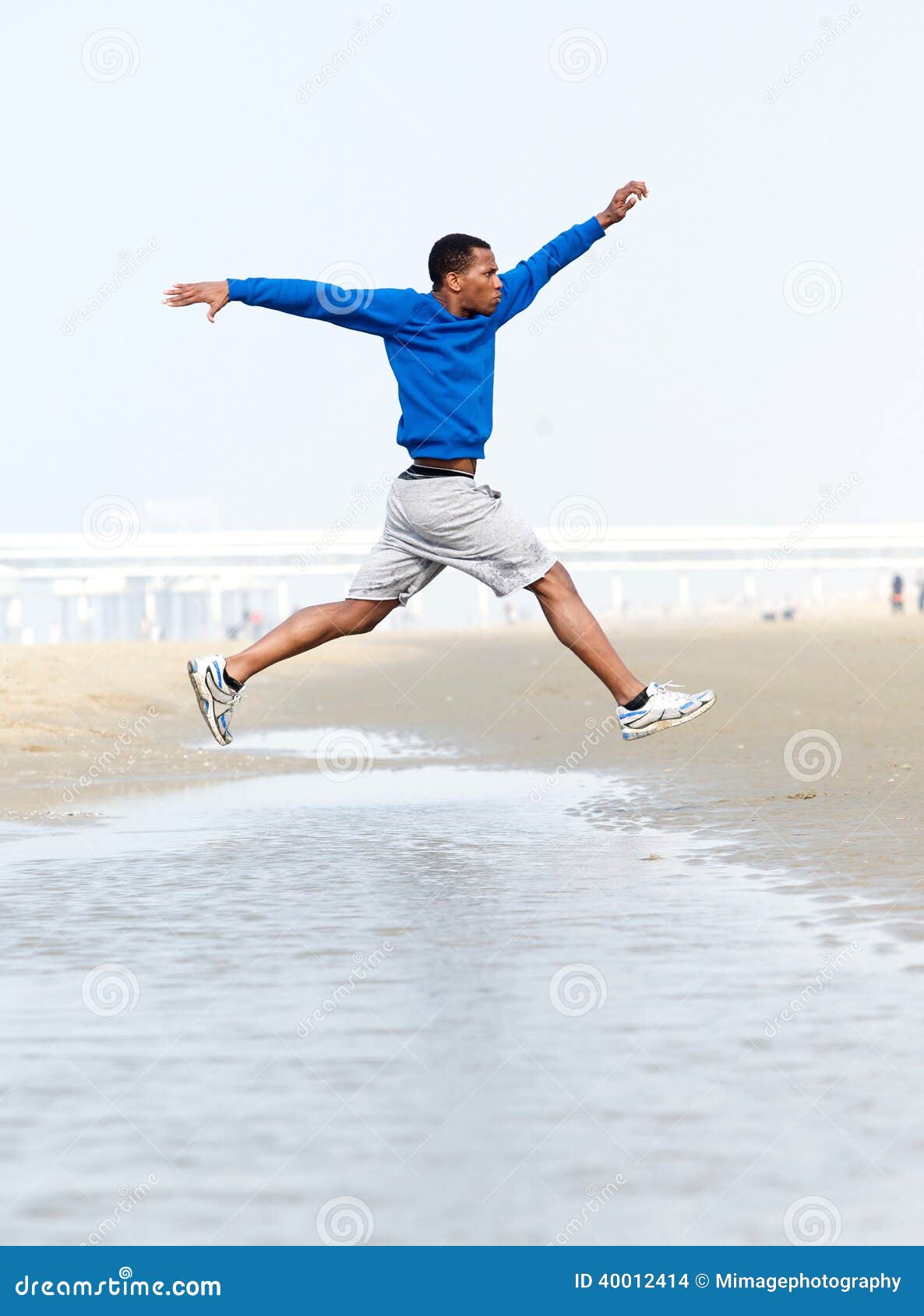 Athletic Man Running and Jumping at Beach Stock Photo - Image of ...
