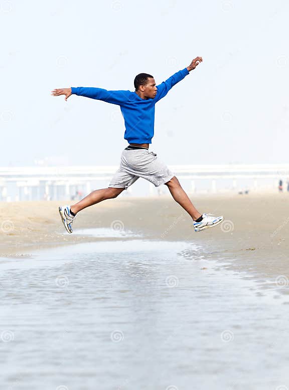 Athletic Man Running and Jumping at Beach Stock Photo - Image of ...