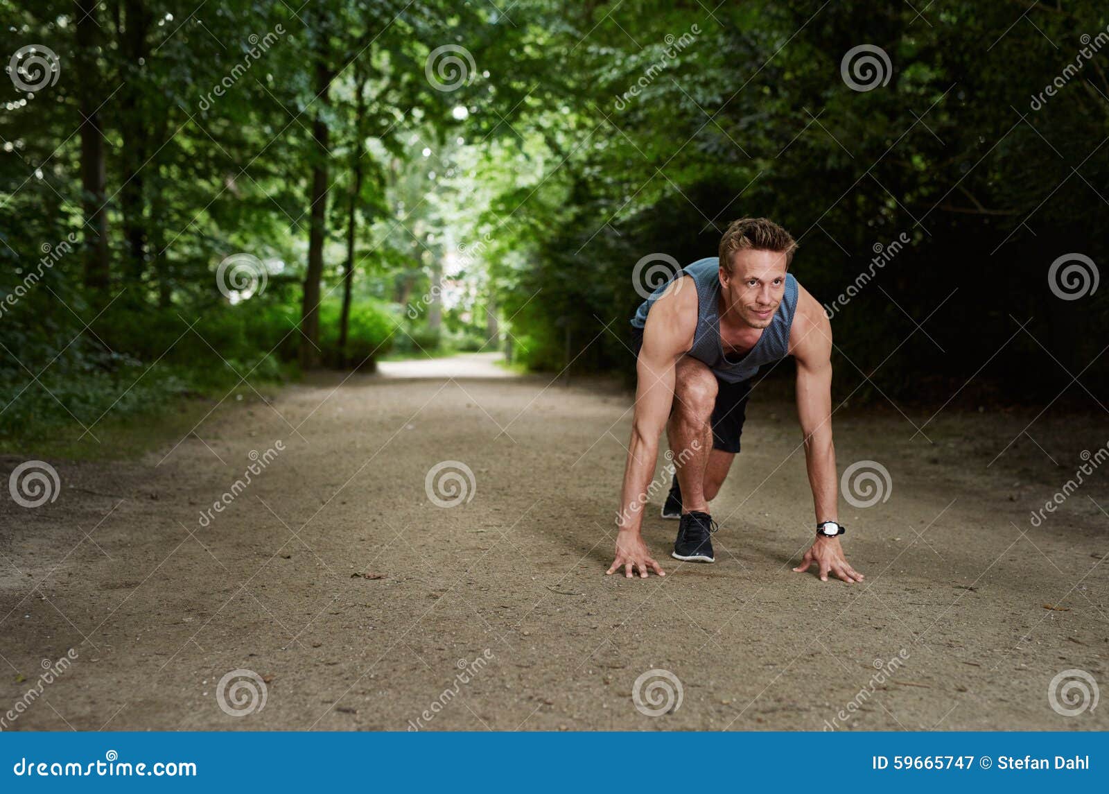 Athletic Man in Running Start Position at the Park Stock Image - Image ...