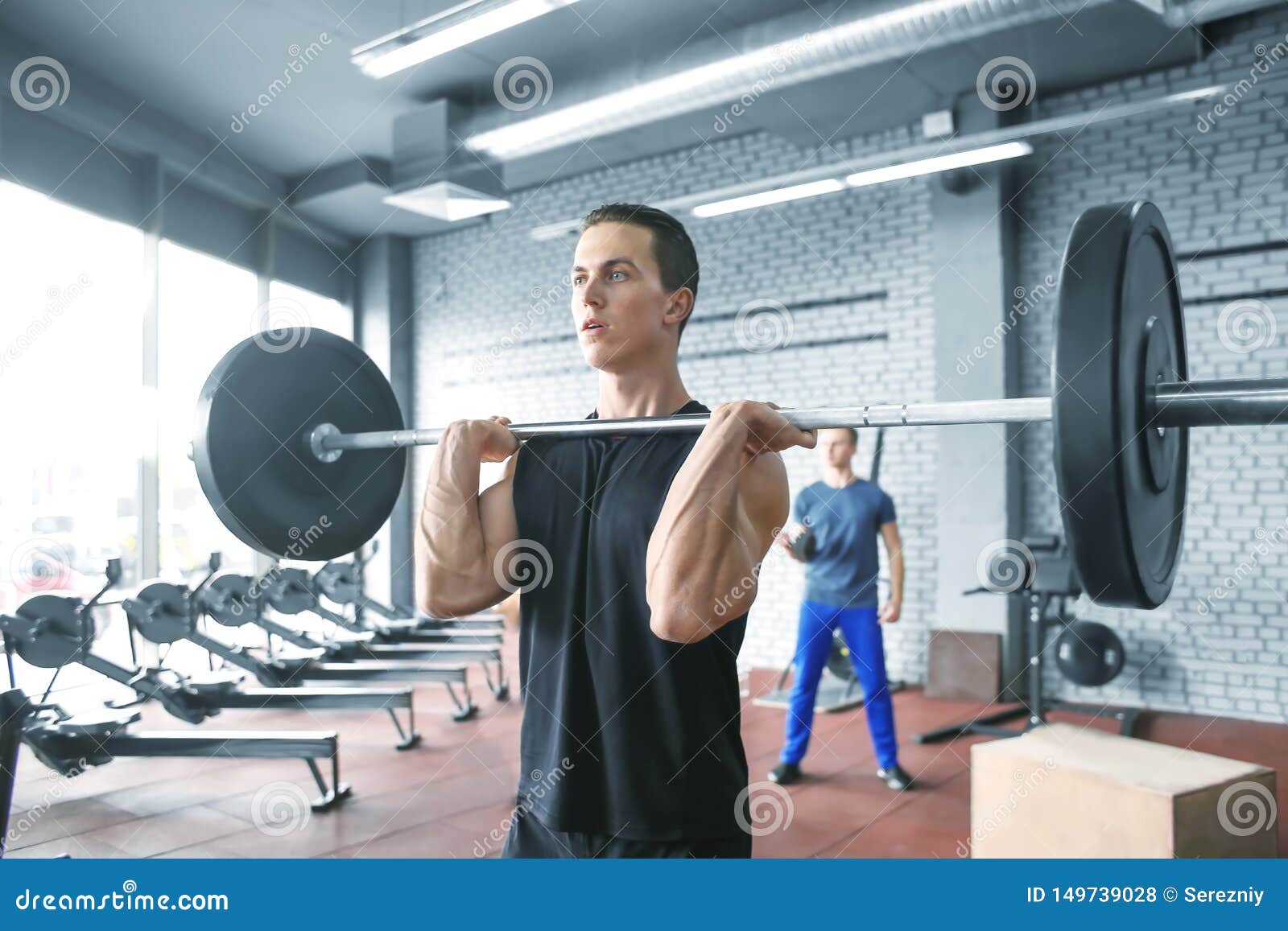Athletic Man Training with Barbell in Modern Gym Stock Photo - Image of ...