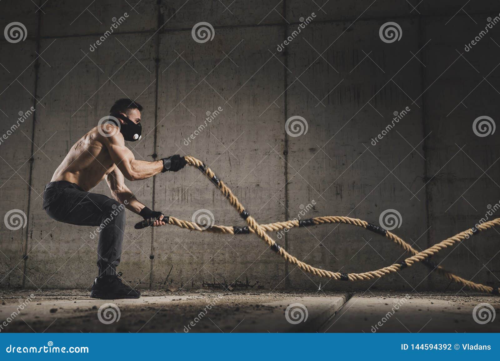 Muscular Man Making Waves with Battle Ropes Stock Photo - Image of ...