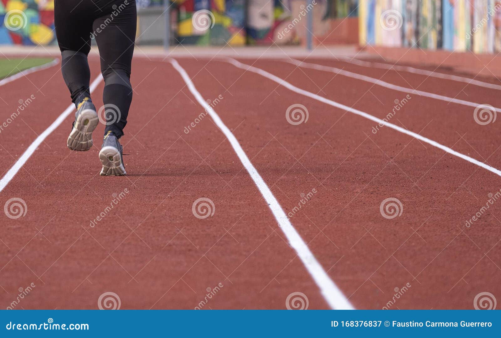 An Athletic Pair of Legs Going for a Run on a Running Track Stock Image ...