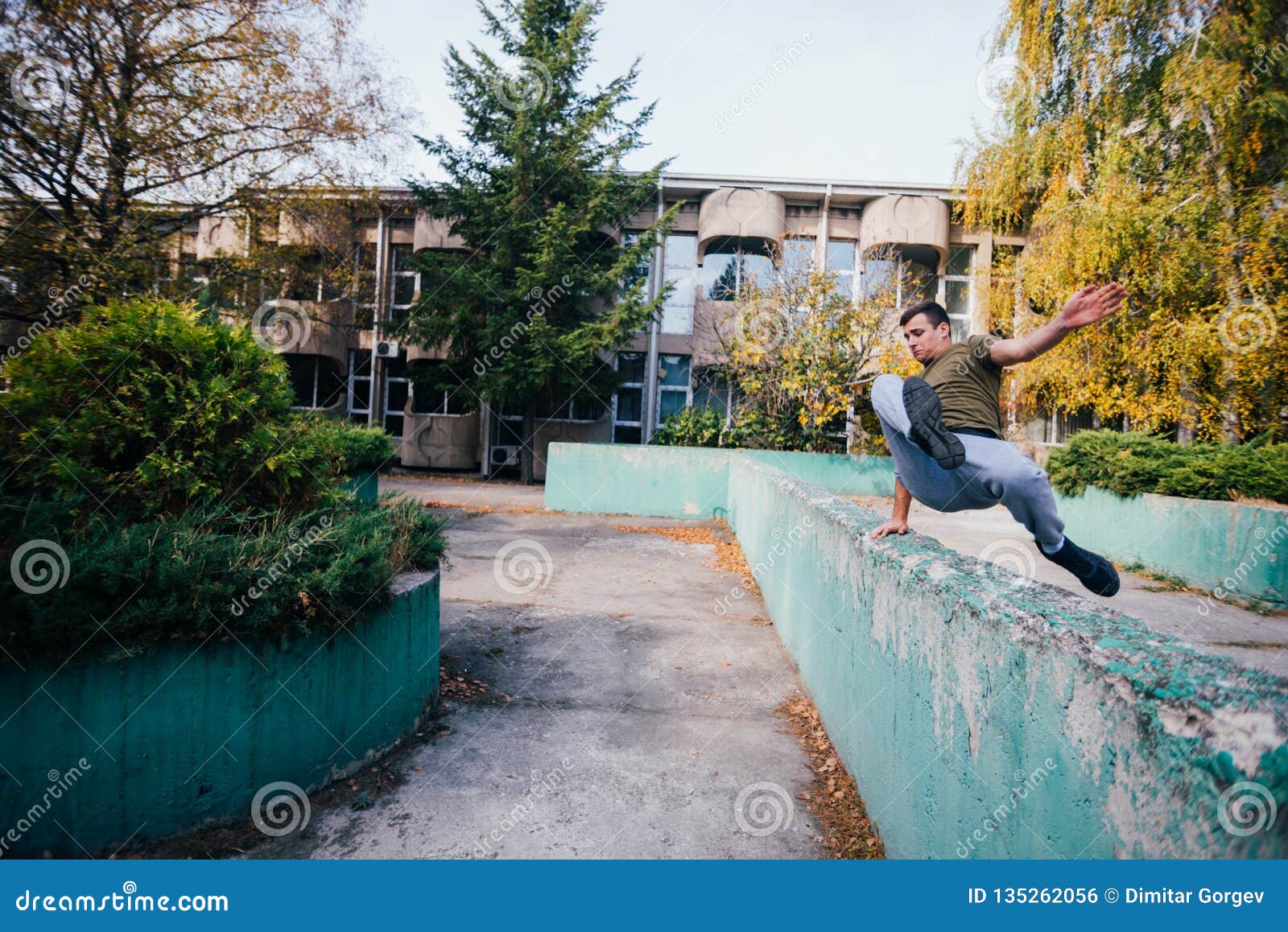Athletic Parkour Guy Doing Backflip and Tricks while Jumping Stock ...