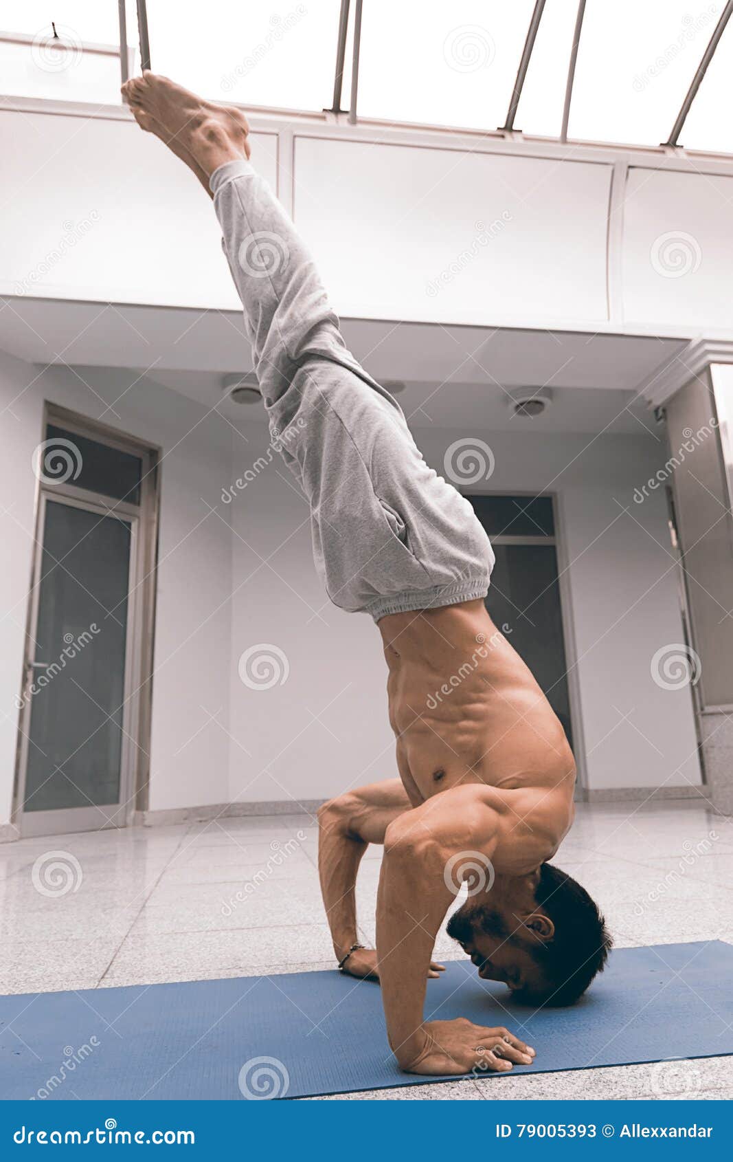 Athletic Strong Man Practicing Difficult Yoga Pose. Stock Image - Image ...