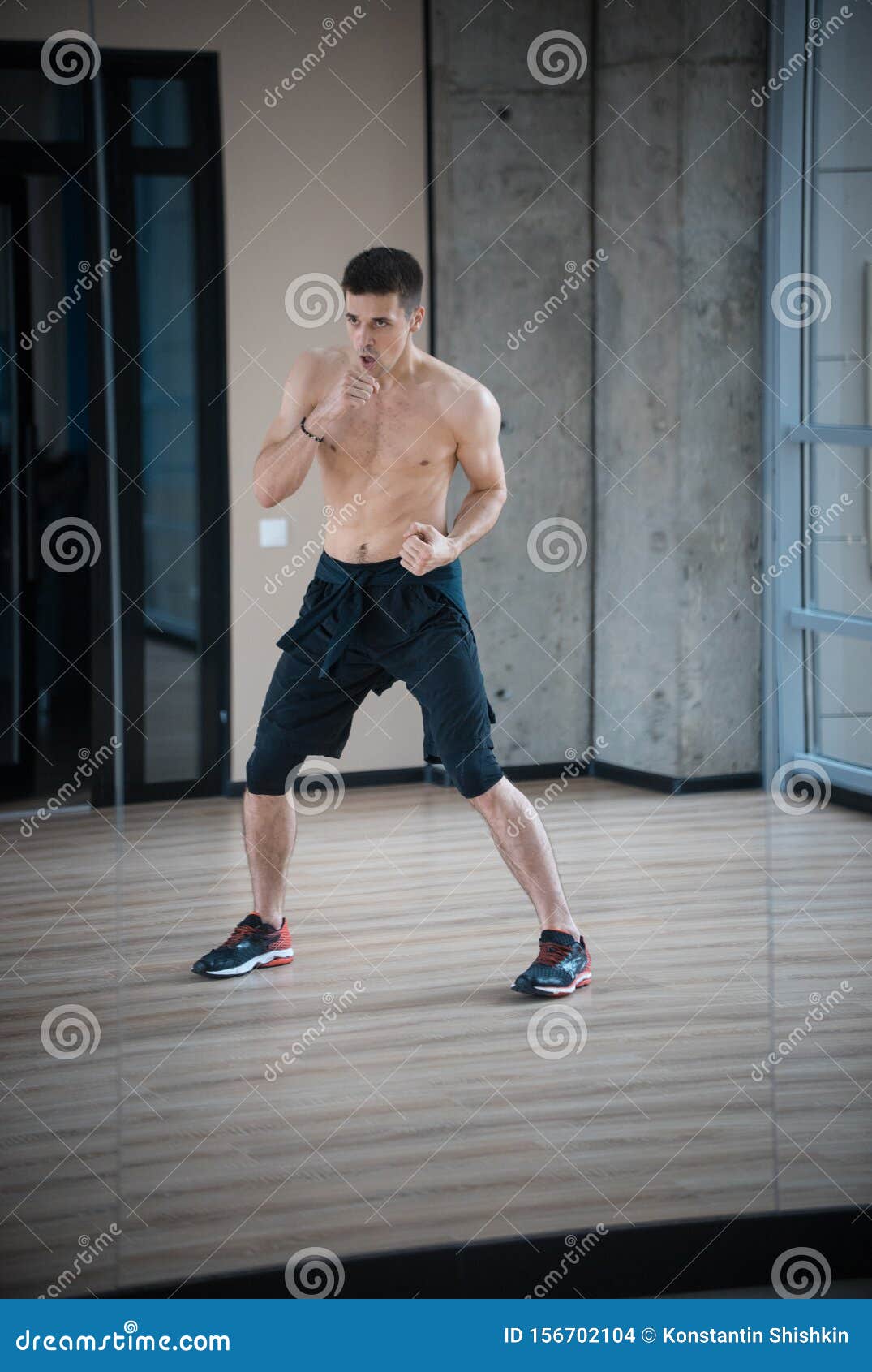 An Athletic Young Man Boxer Standing in Fighting Pose in the Bright ...