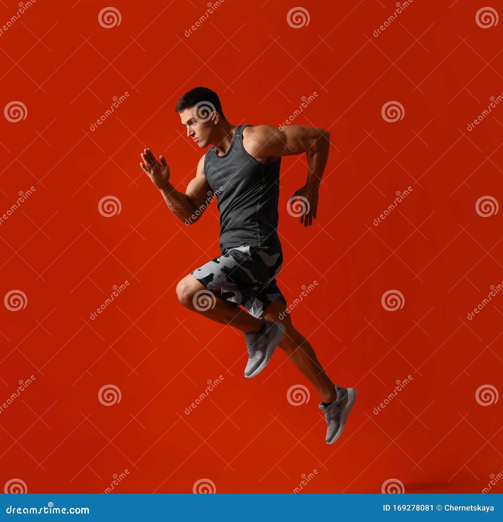 Athletic Young Man Running on Red, Side View Stock Image - Image of ...