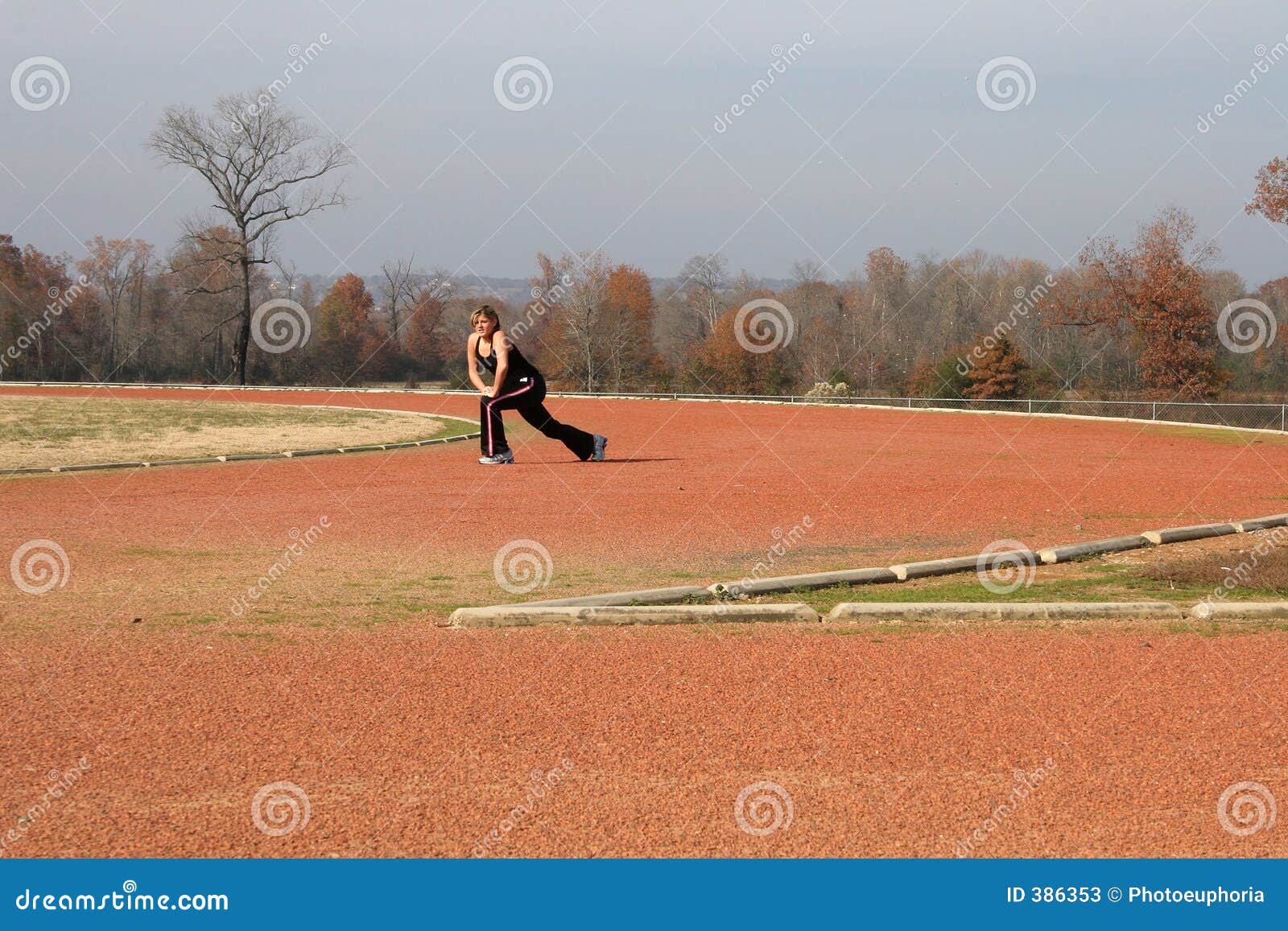 Athletic Young Woman Stretching at the Track Stock Image - Image of ...