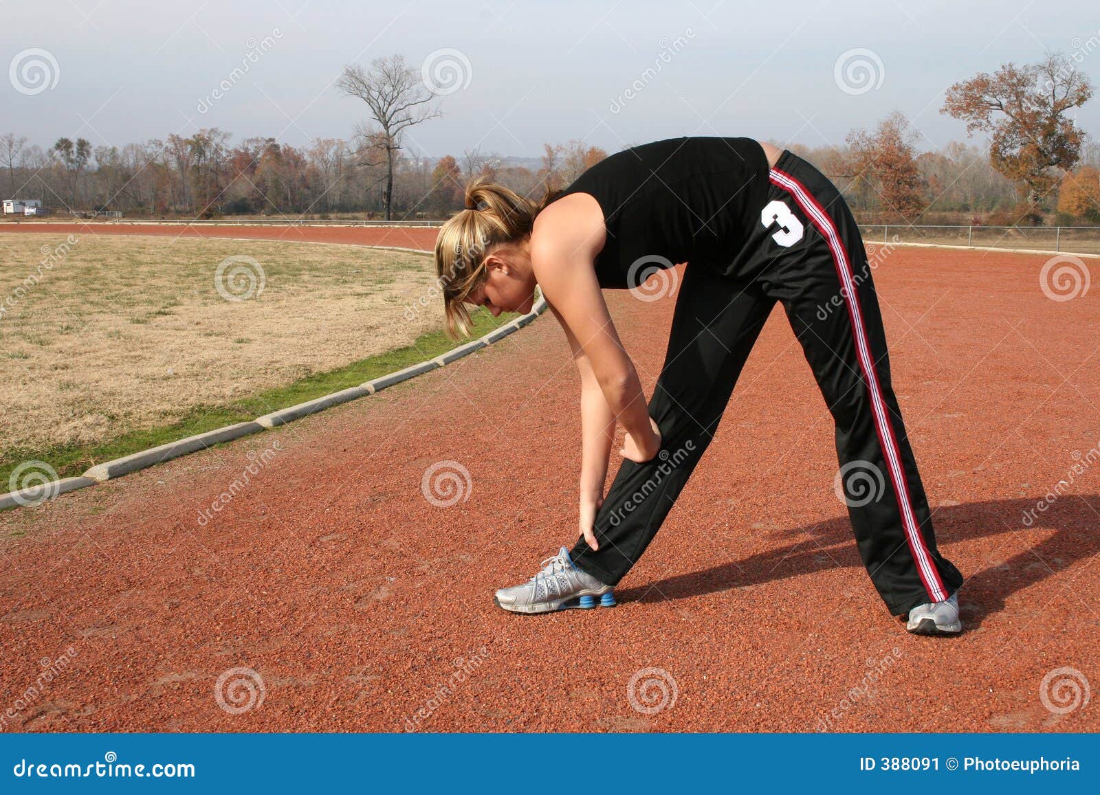 Athletic Young Woman Stretching at the Track Stock Image - Image of ...