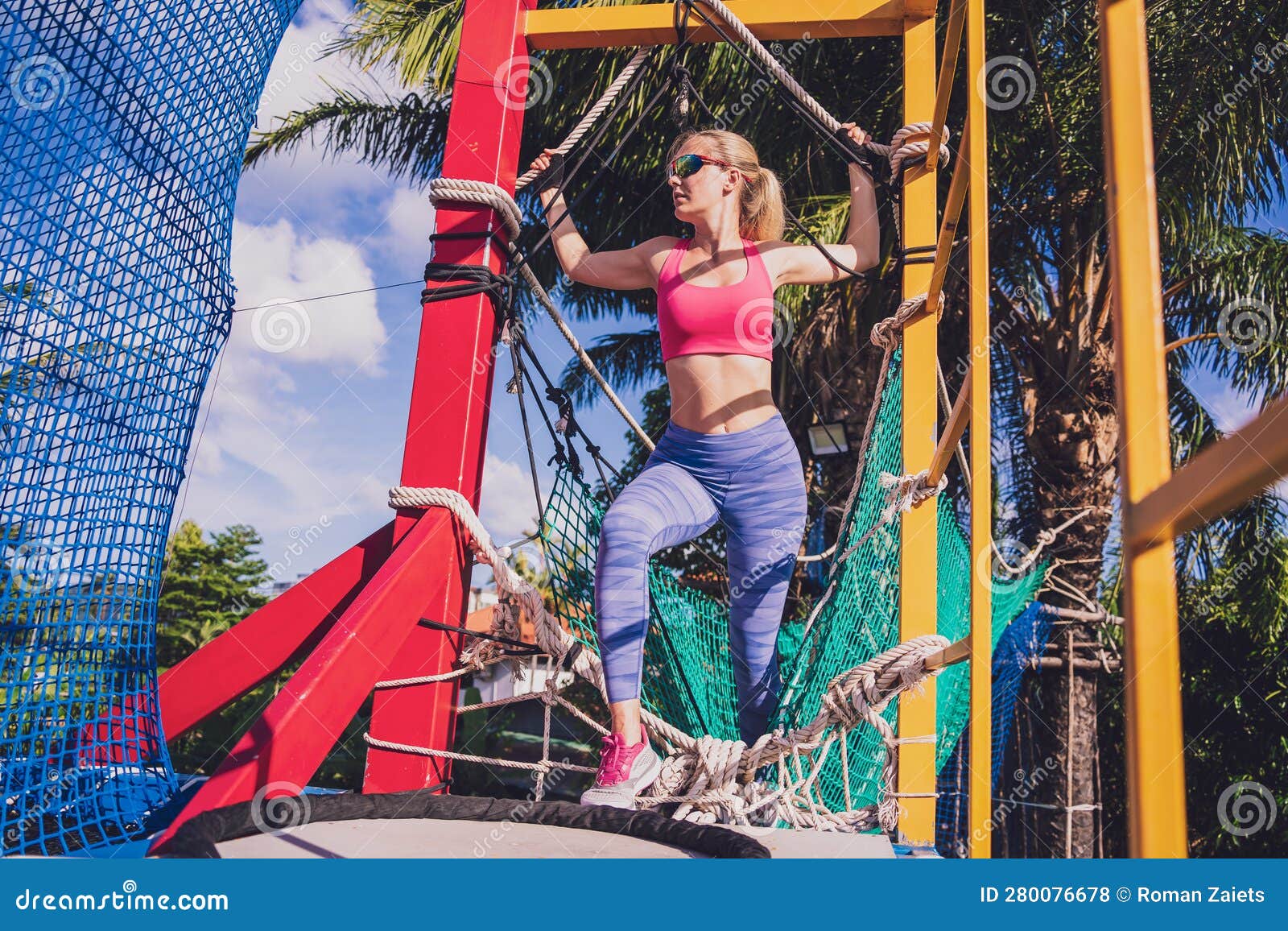 Athletic Young Woman Working Out at the Rope Training Camp. Stock Photo ...