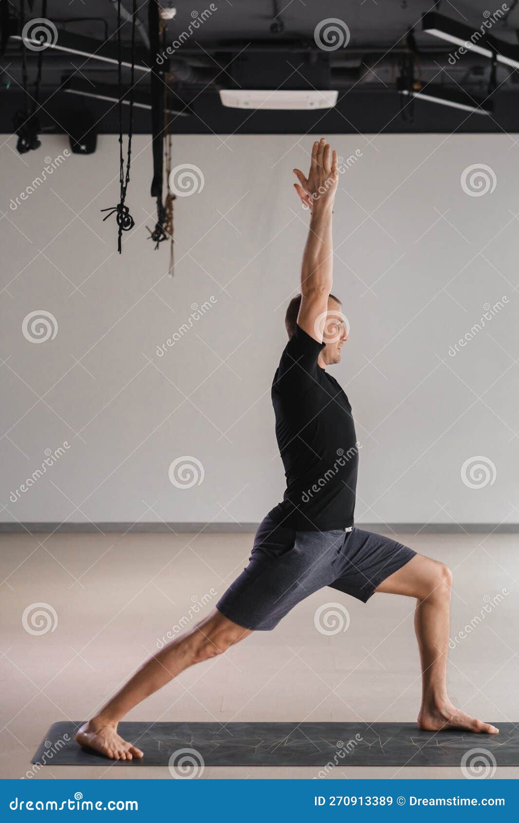 An Athletically Built Man Does Yoga in the Gym on a Mat Stock Image ...