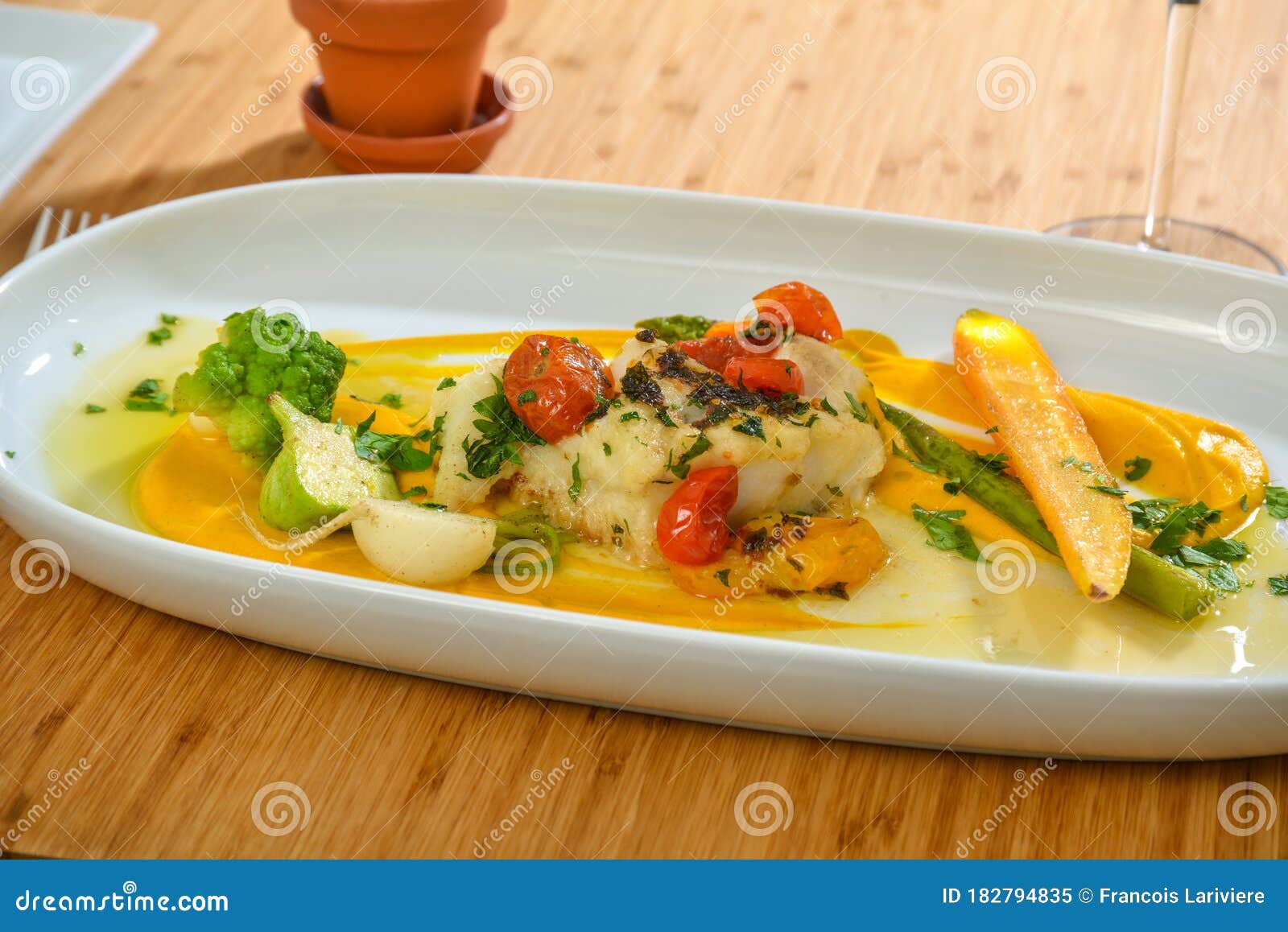 Atlantic Cod Dish Served with Asparagus, Red Tomatoes and Vegetables ...