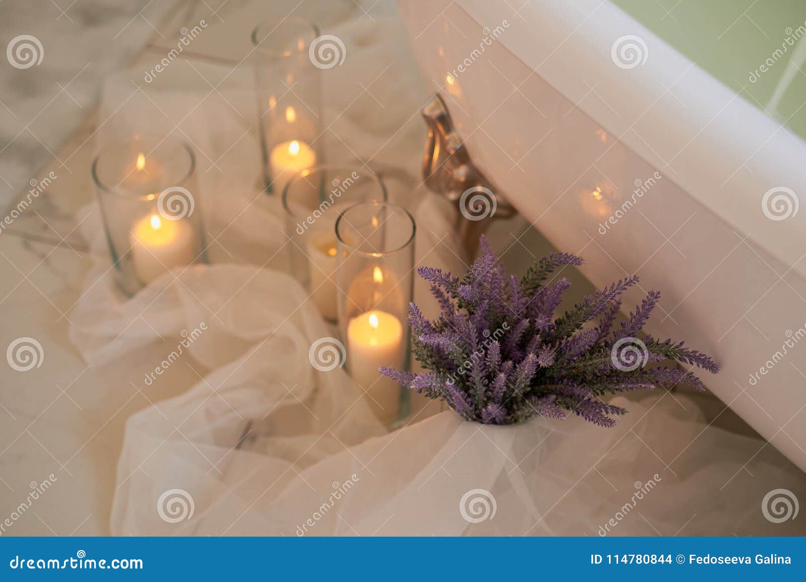 The Atmosphere of Relaxation. Burning Candles and a Bunch of Lavender ...