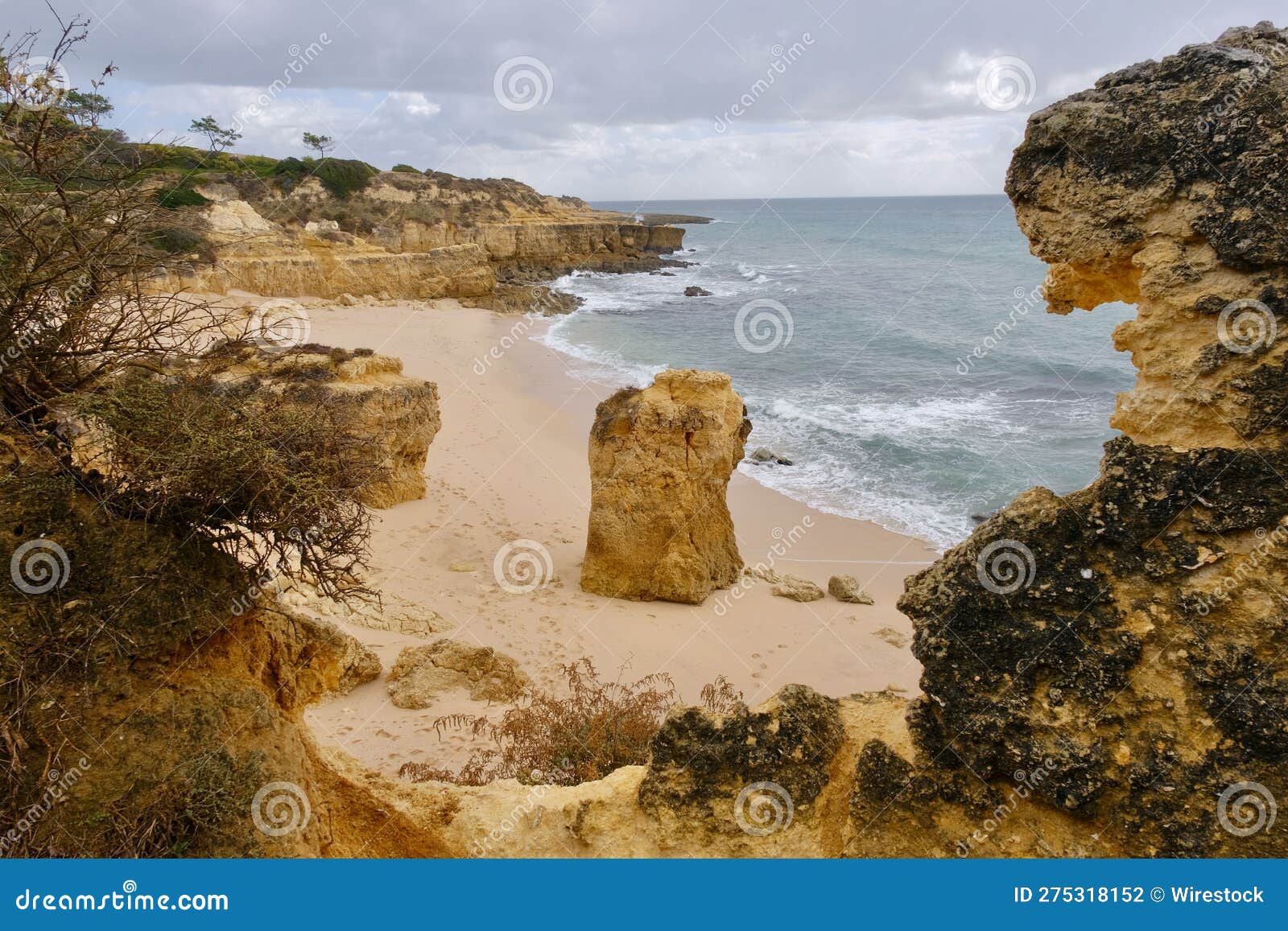 An Overcast Sky Hangs Over the Beach and Cliffs Near a Sandy Shore ...