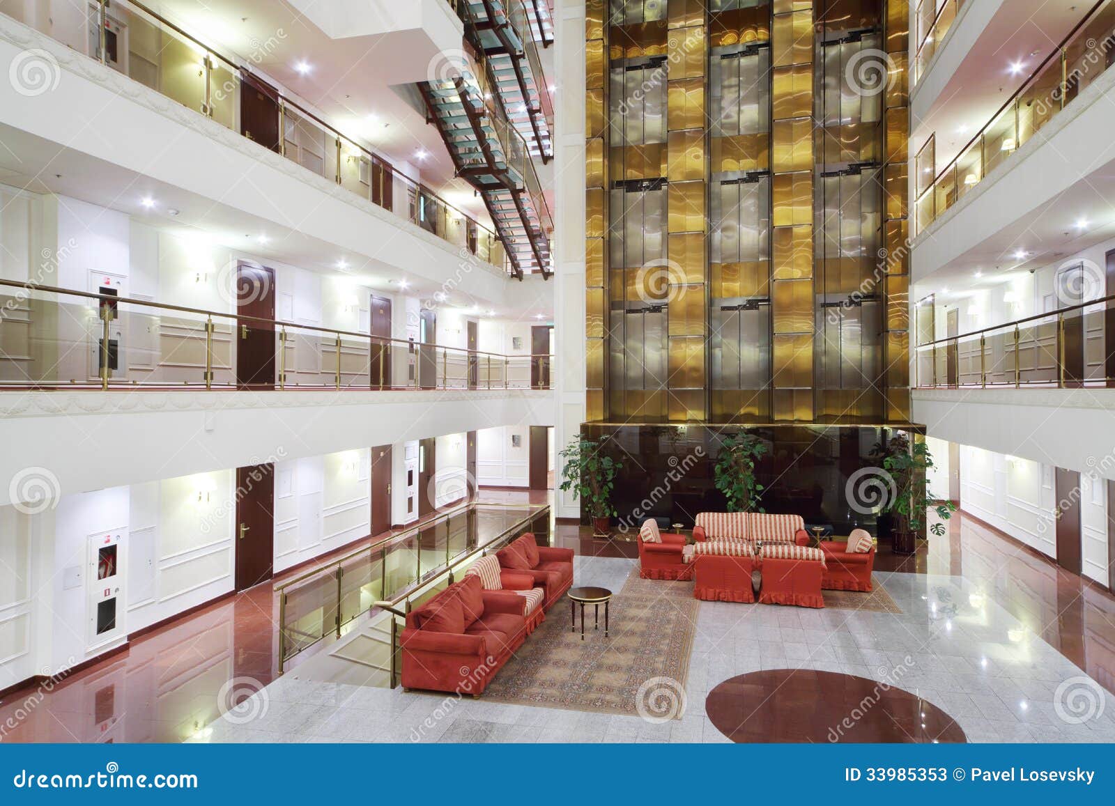 Atrium with Red Armchairs, Couches and Elevators Stock Image - Image of ...