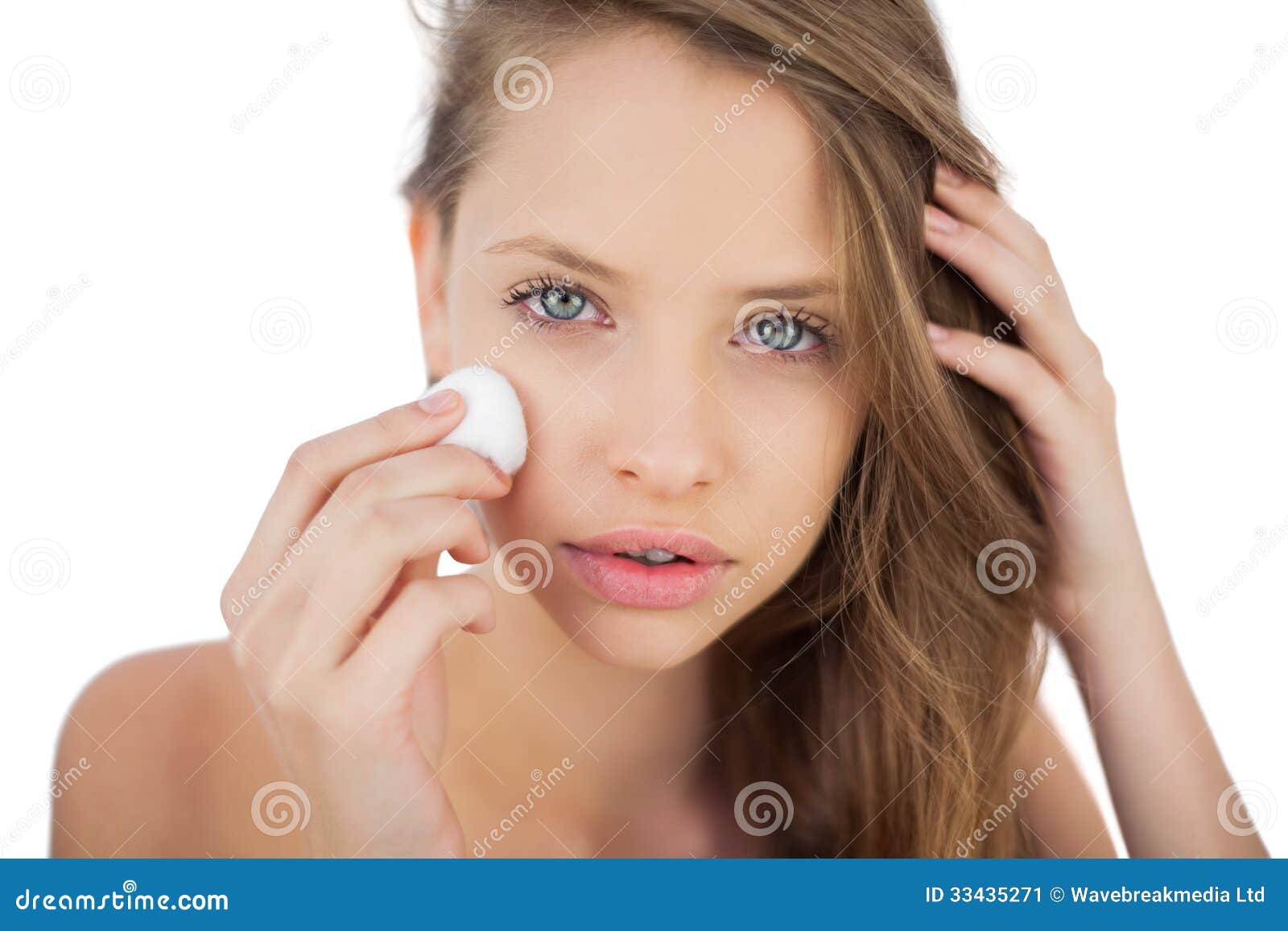 Attentive Brunette Model Rubbing Her Face With Cream Stock Image