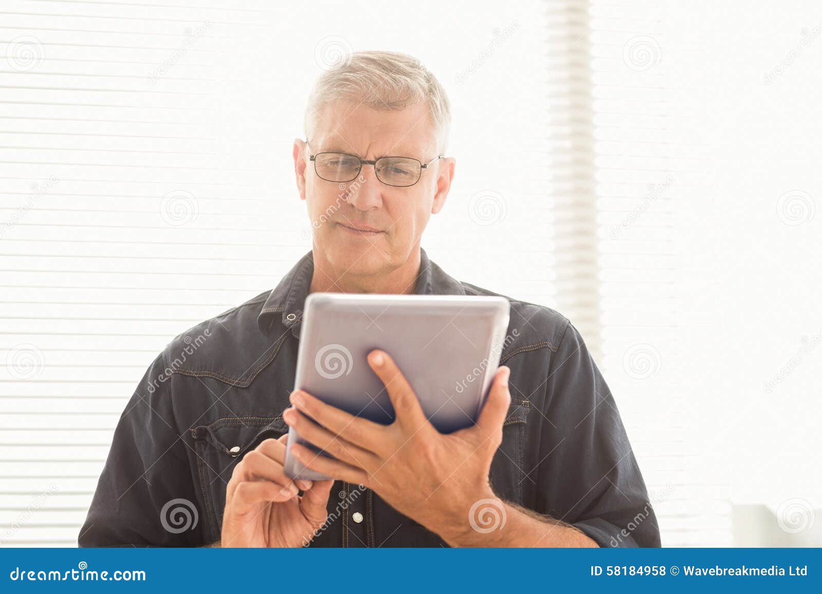 Attentive Businessman Scrolling on His Tablet Stock Photo - Image of ...
