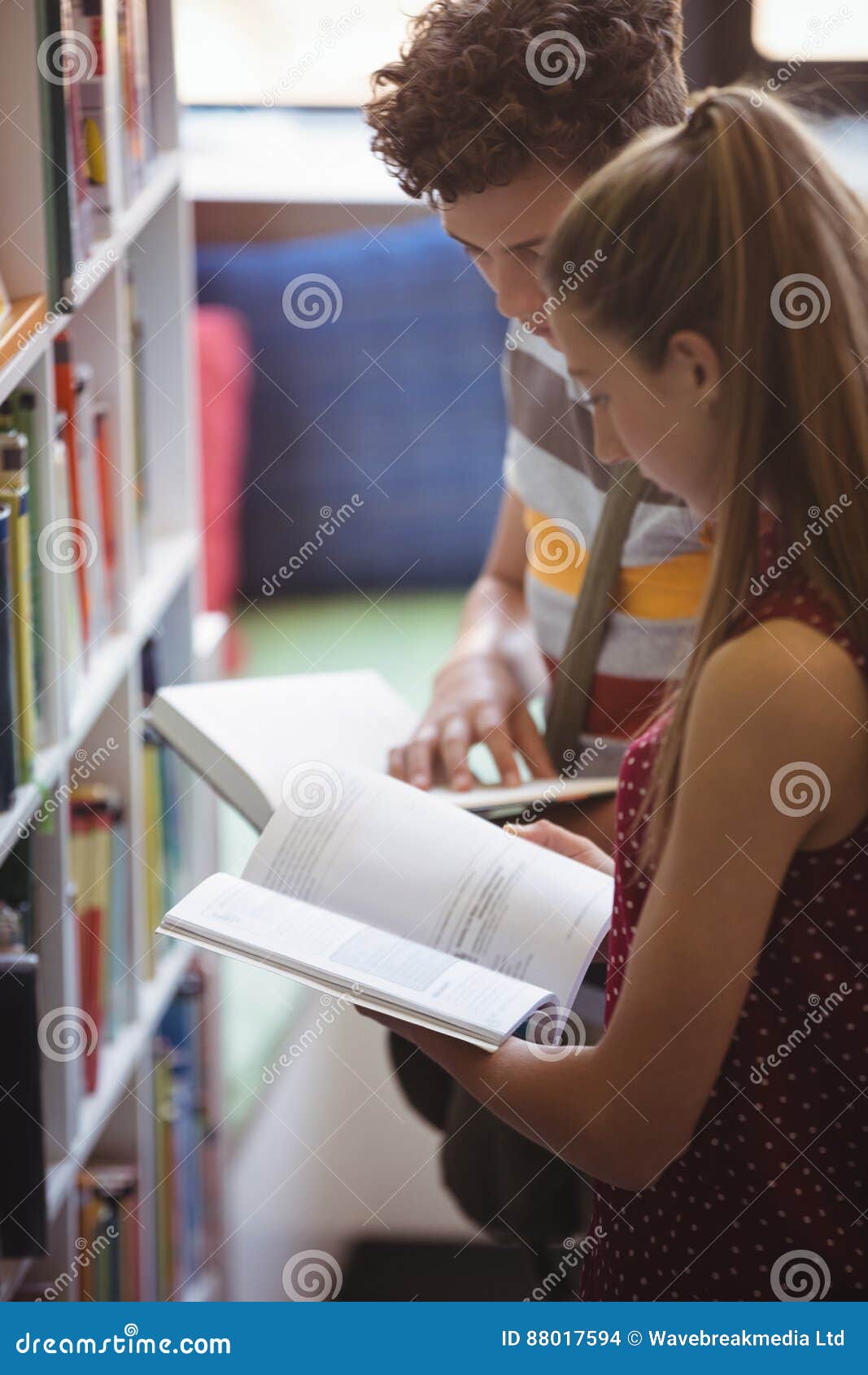 Attentive Classmates Reading Book in Library Stock Photo - Image of ...