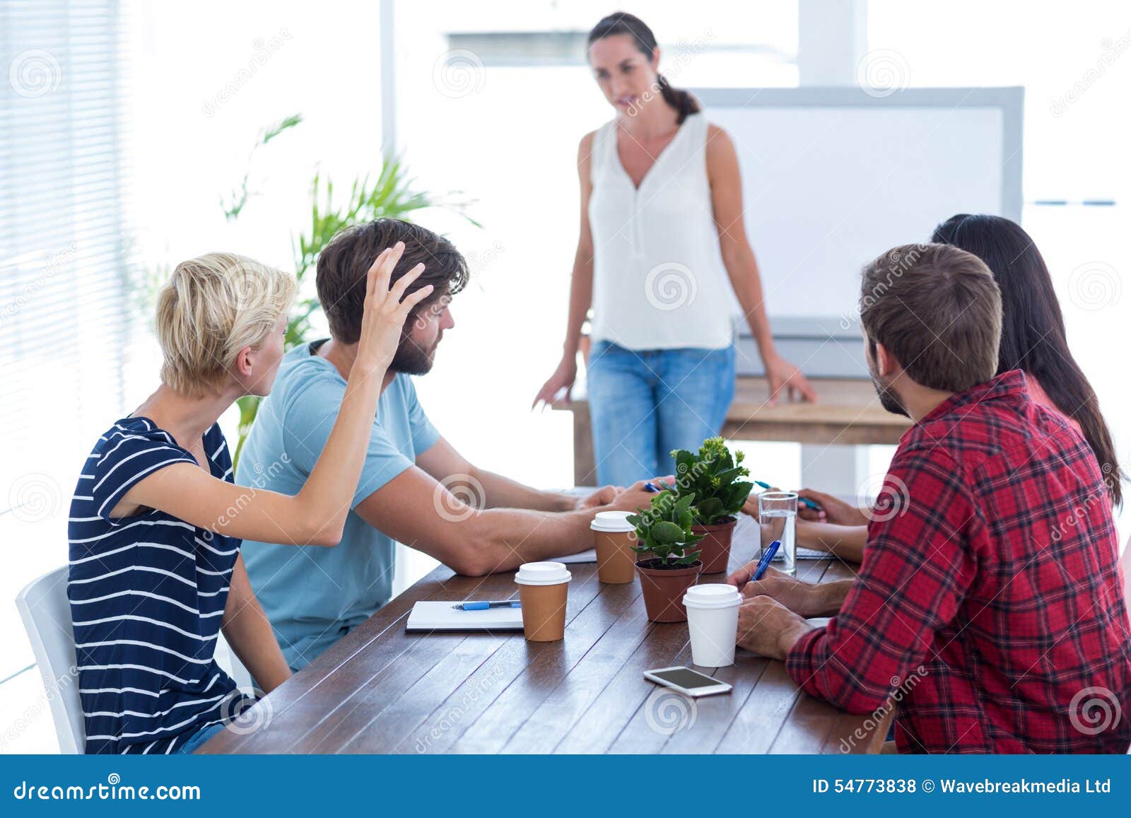 Attentive Colleague Asking a Question in a Meeting Stock Photo - Image ...